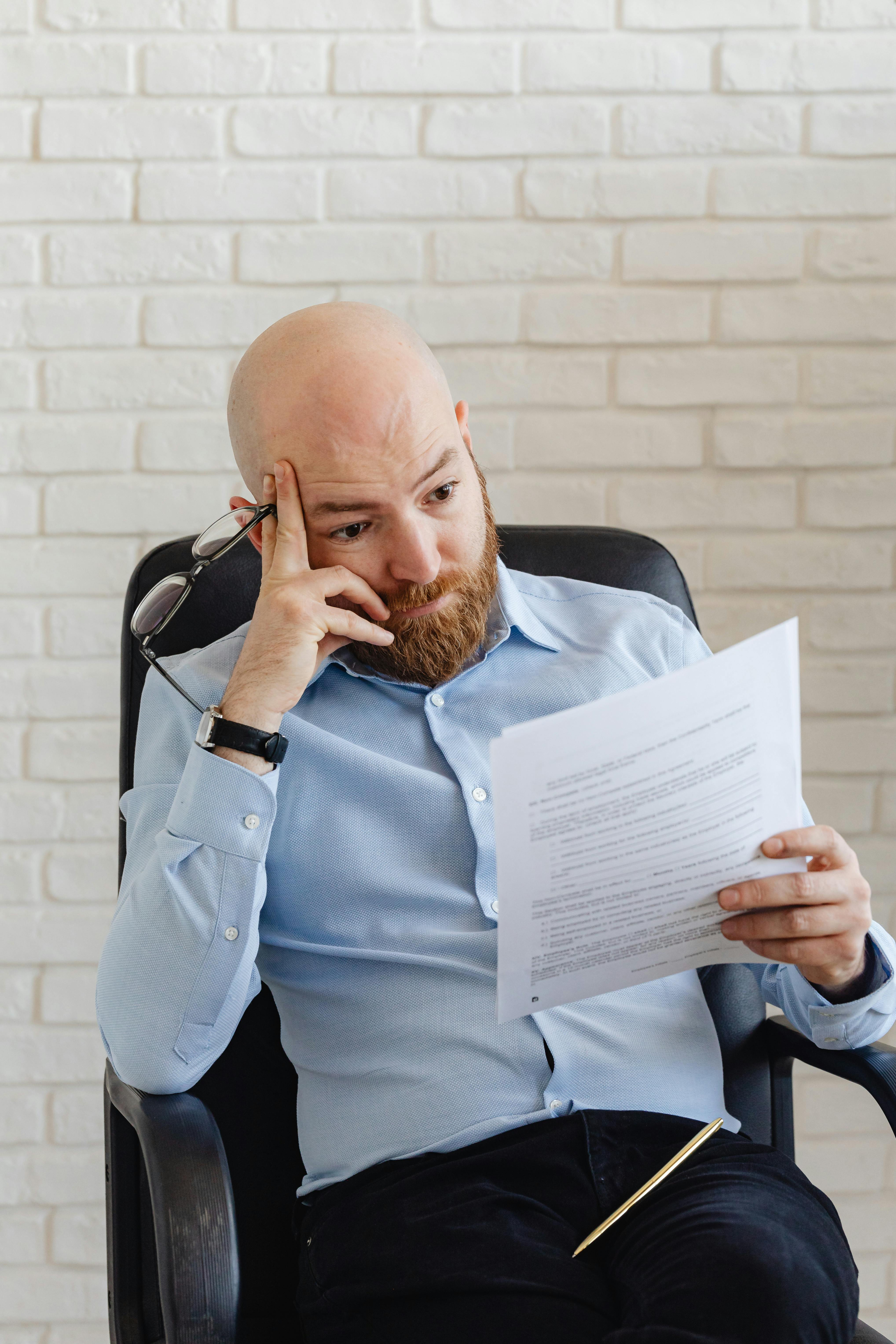 A Man Reading a Document · Free Stock Photo