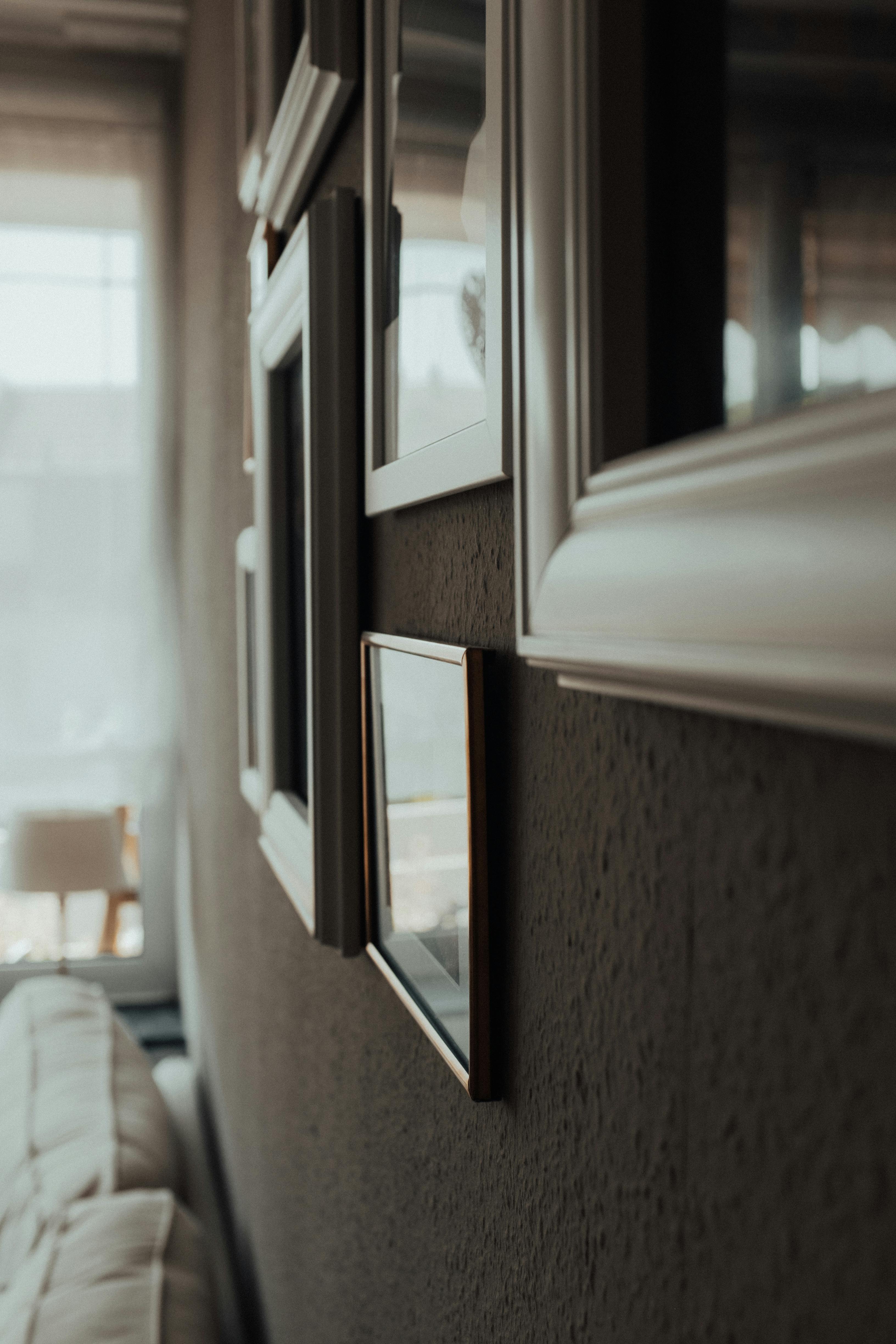Silhouette Photo of Person Standing Near Photo Frames · Free Stock Photo