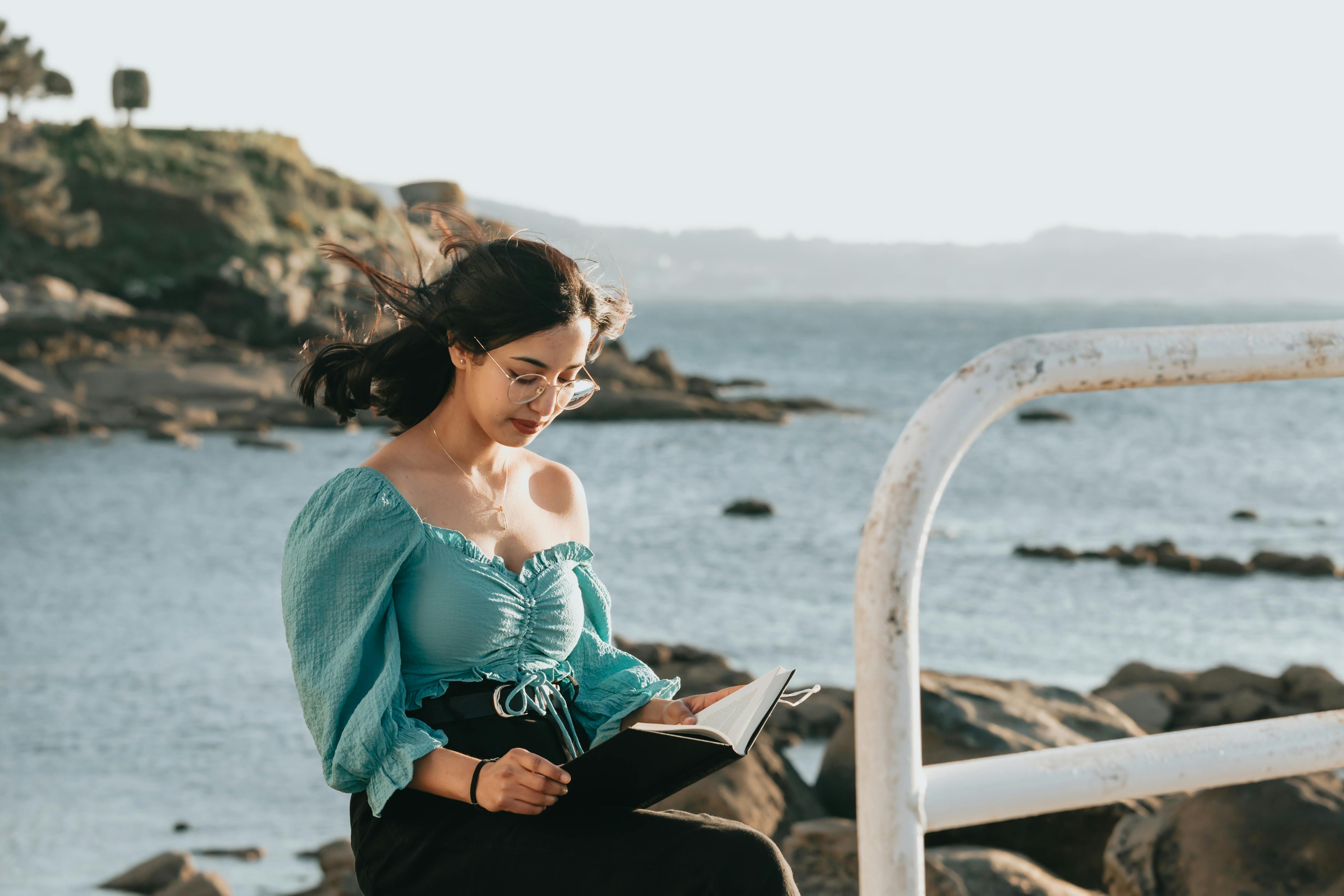 Woman Reading Book by Sea · Free Stock Photo