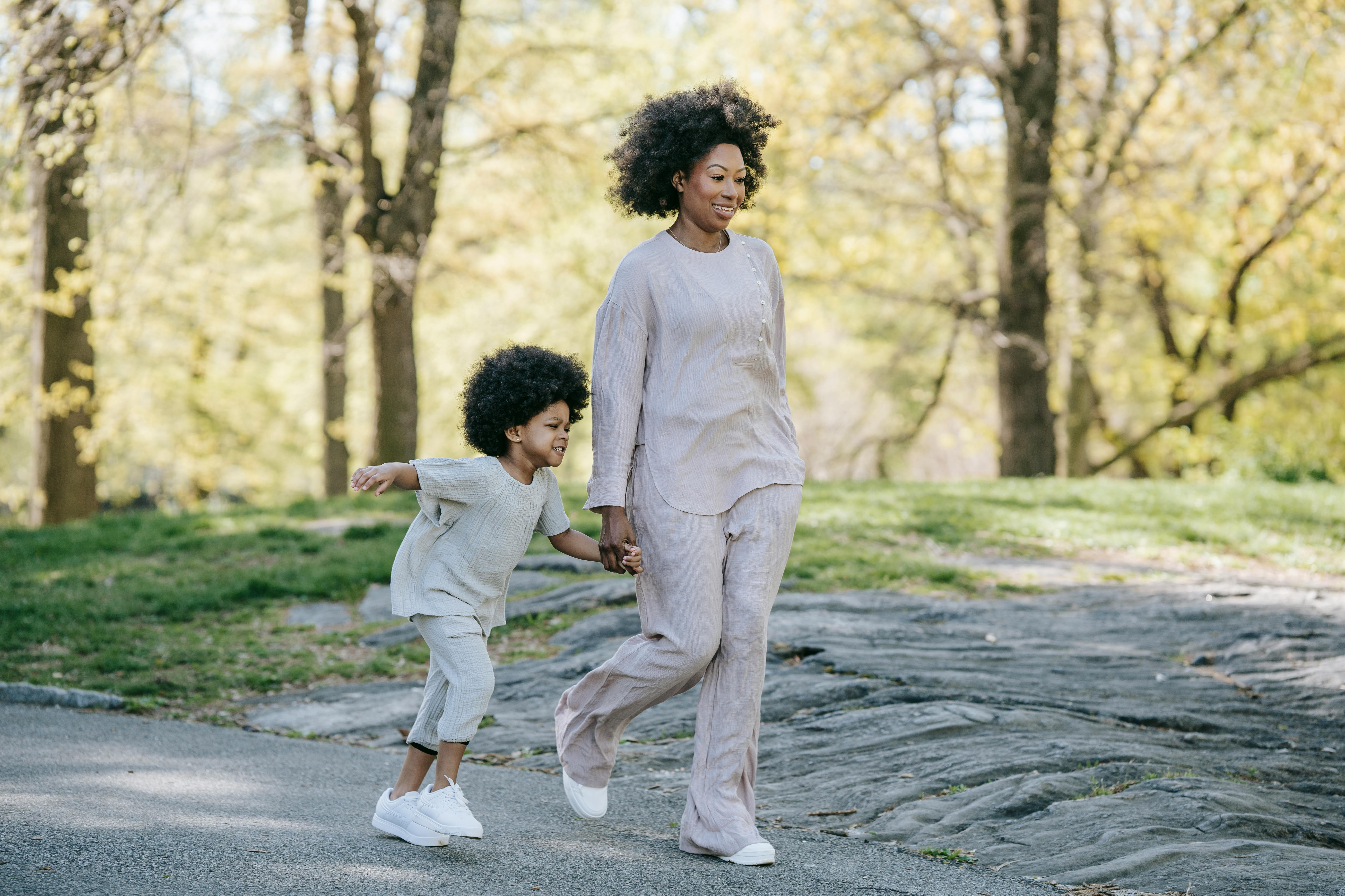 Smiling Woman Walking with a Boy · Free Stock Photo