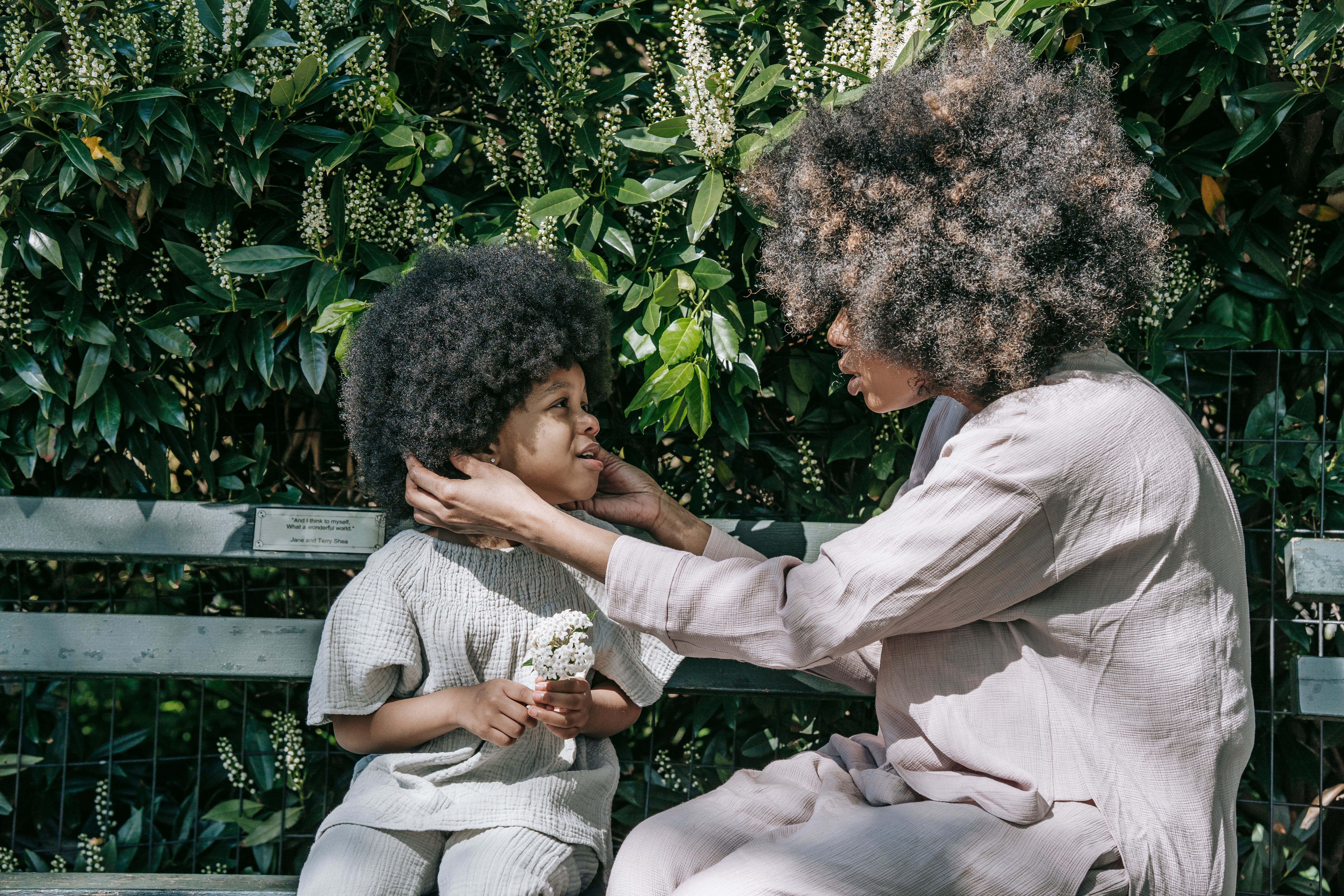 Mother and Child Sitting on Bench in Park · Free Stock Photo