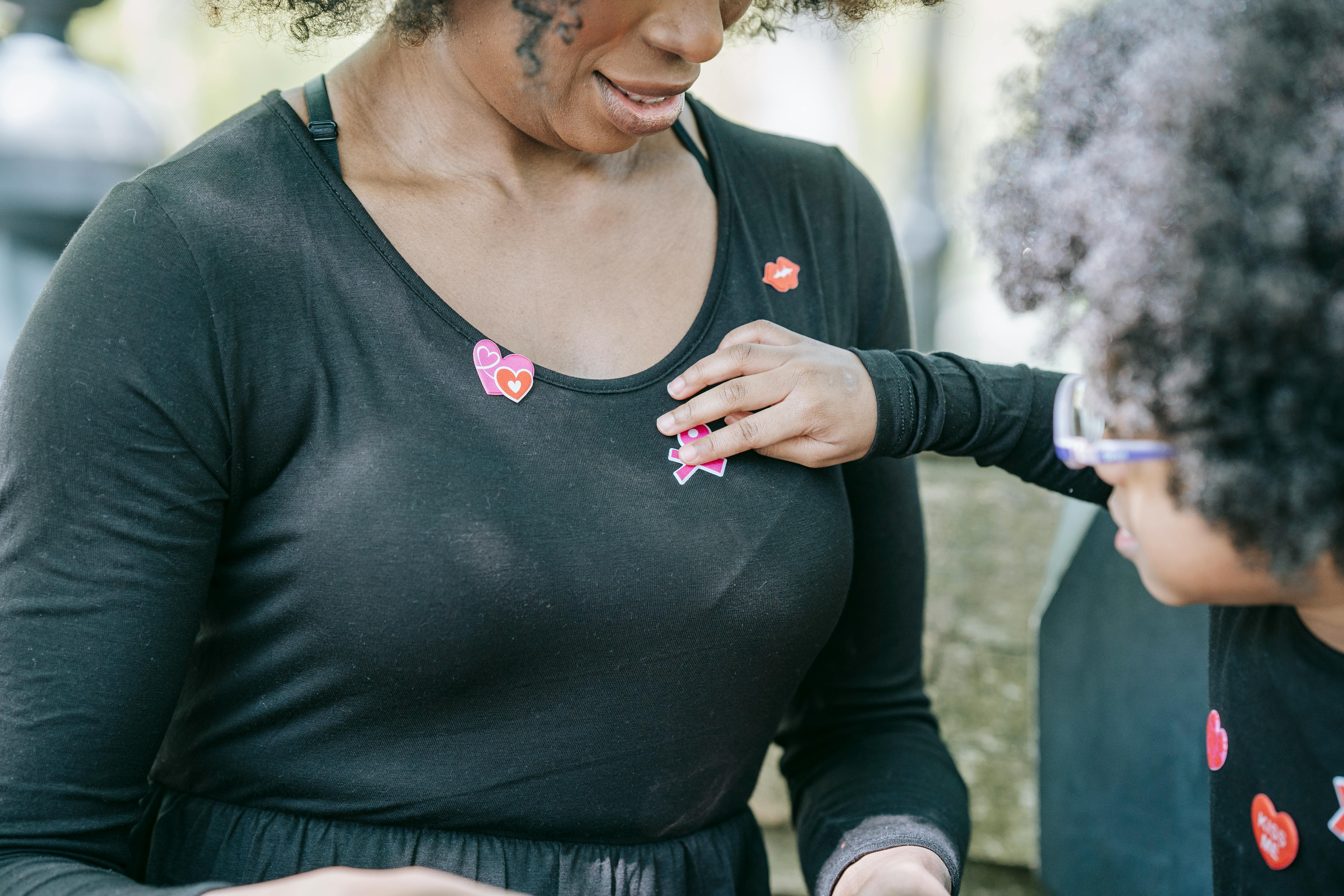 A Child Placing Stickers on her Mom · Free Stock Photo