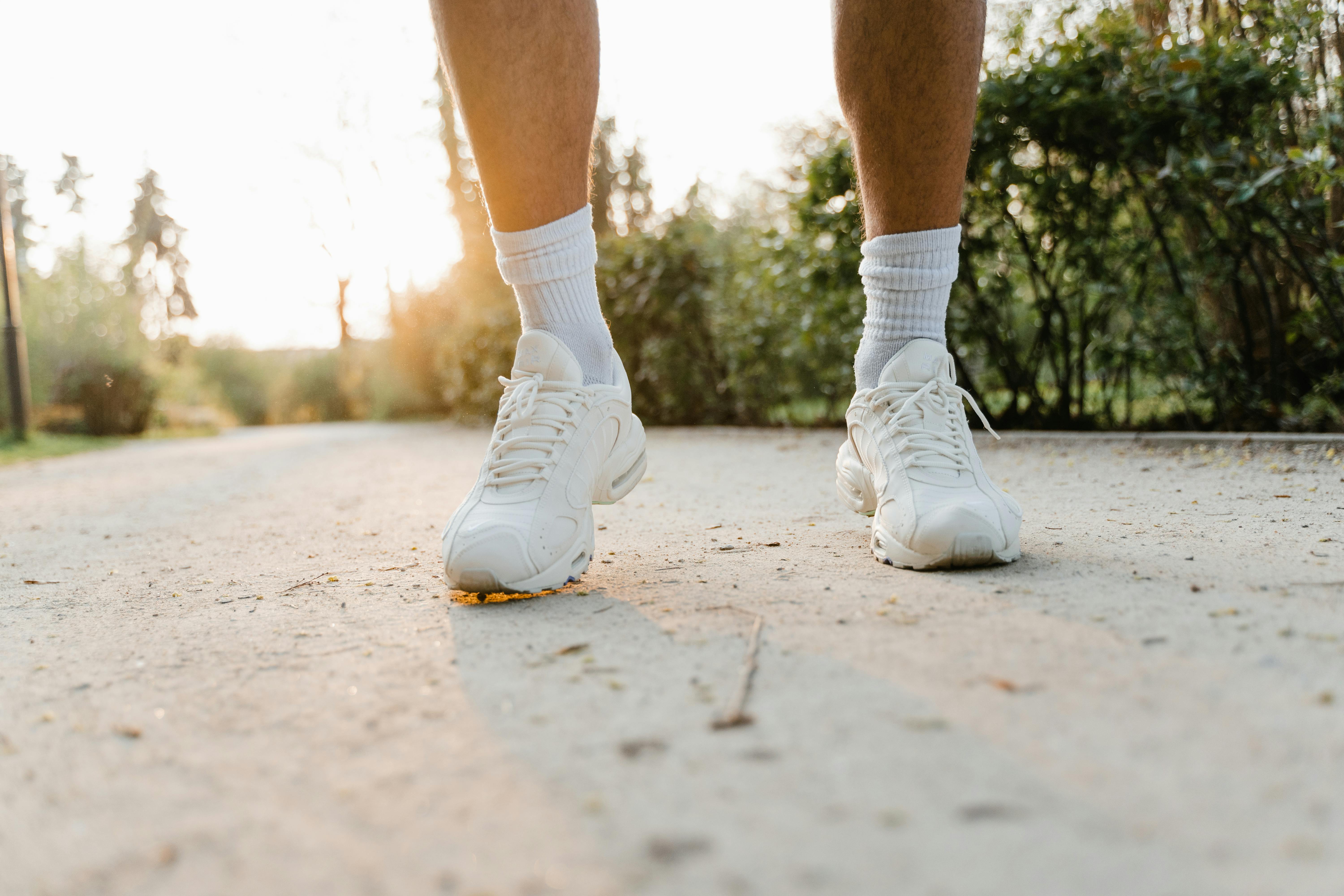 A Person Wearing White Shoes and White Socks · Free Stock Photo