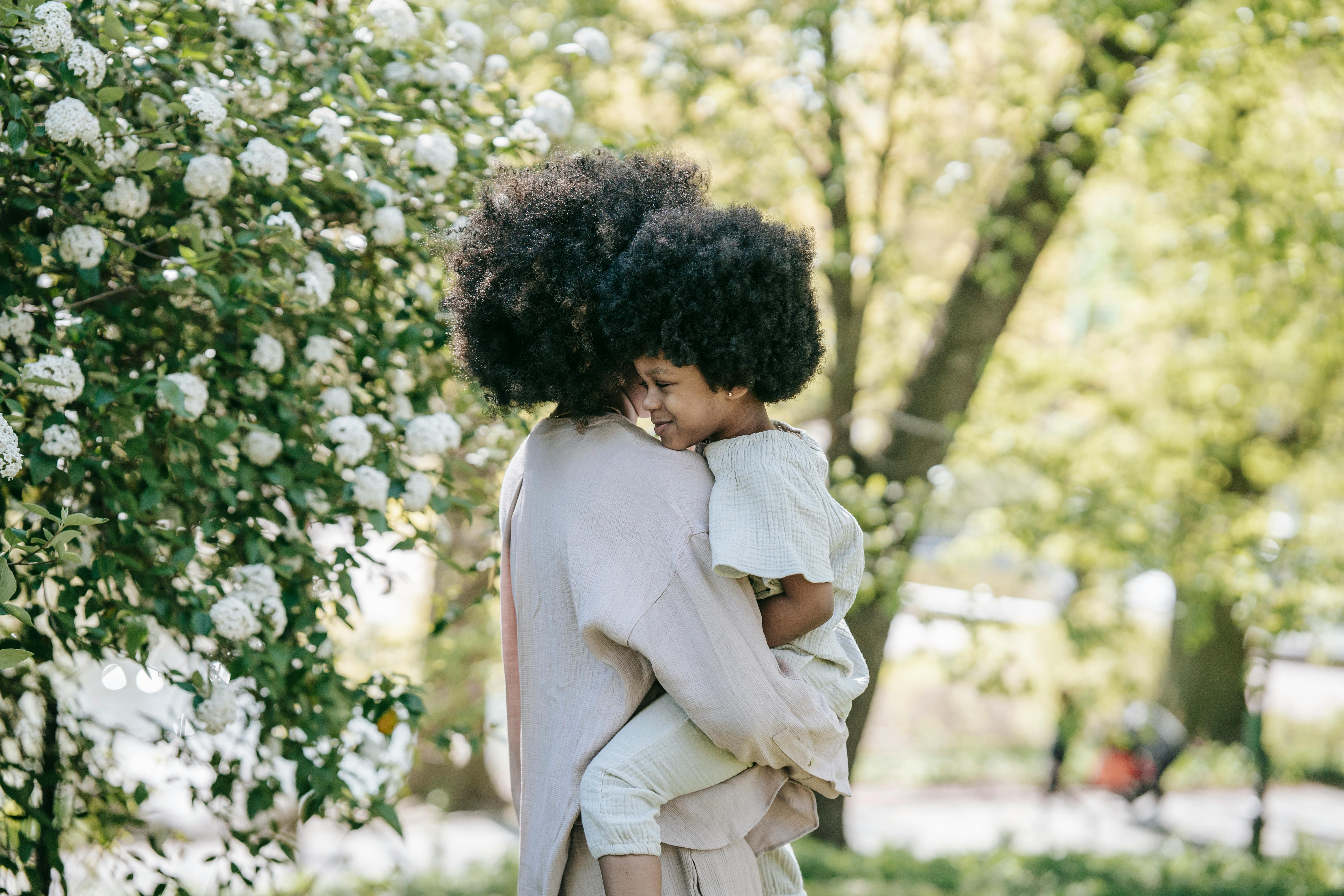 A Person Carrying a Child · Free Stock Photo
