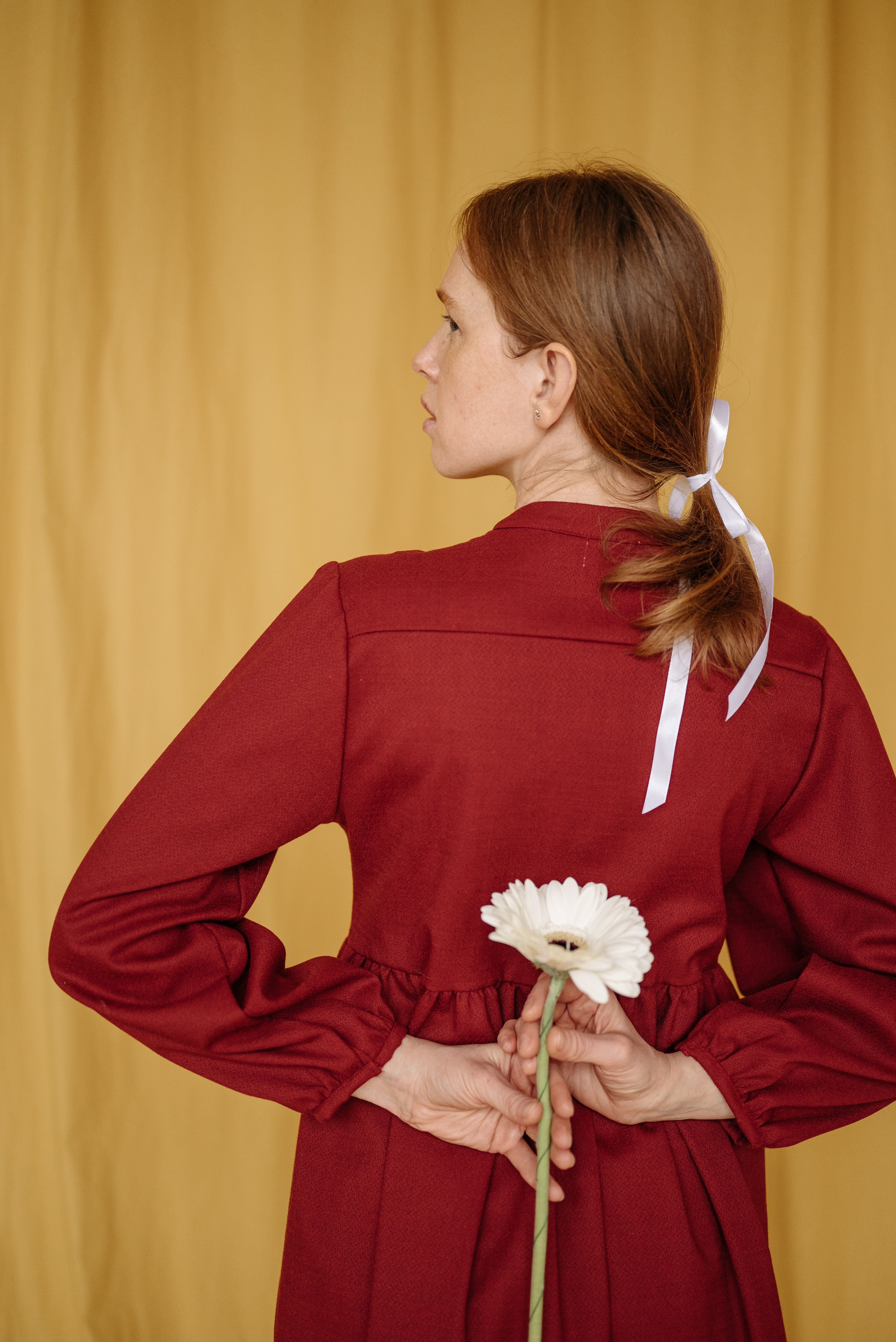 Young Woman Standing with Hands Behind Back · Free Stock Photo
