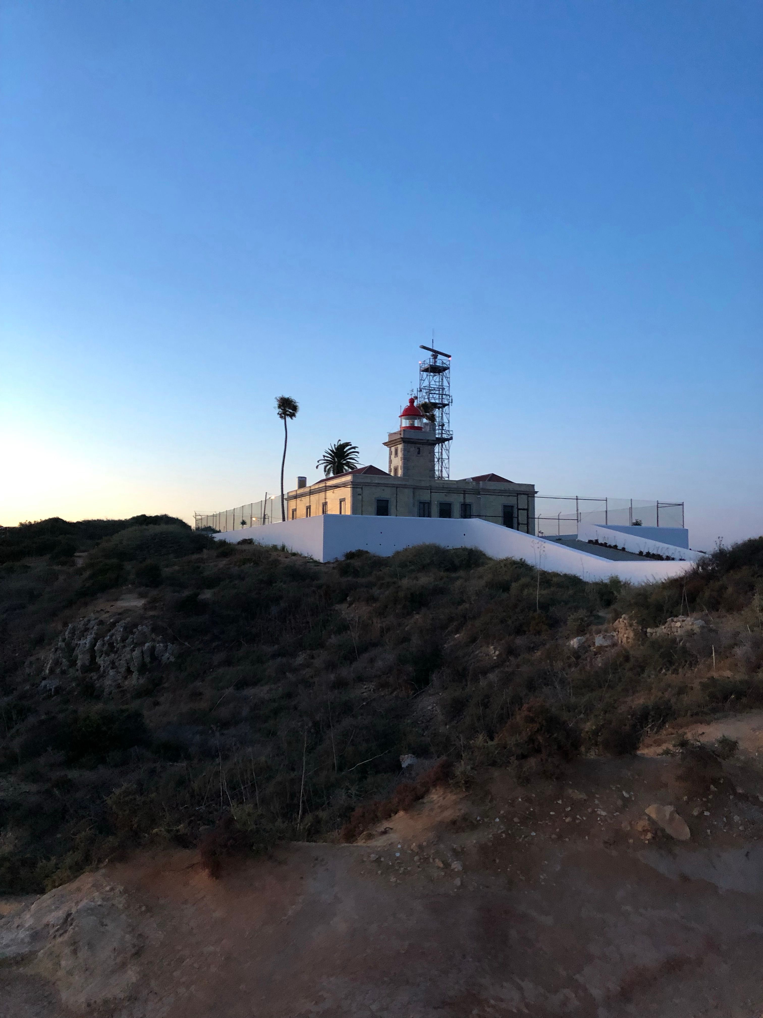 Lighthouse on Cliff on Sunset · Free Stock Photo