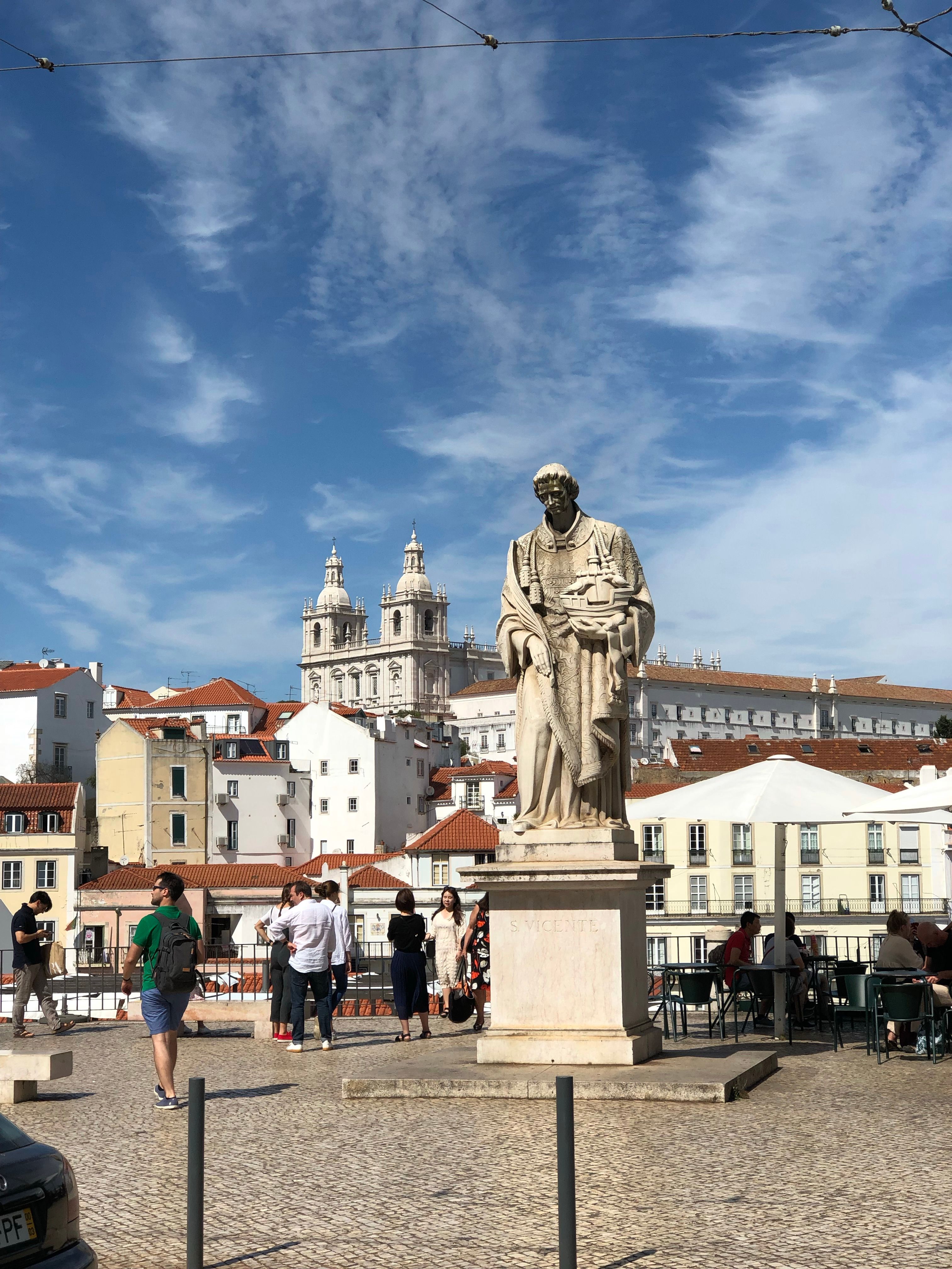 People Walking Beside a Statue · Free Stock Photo
