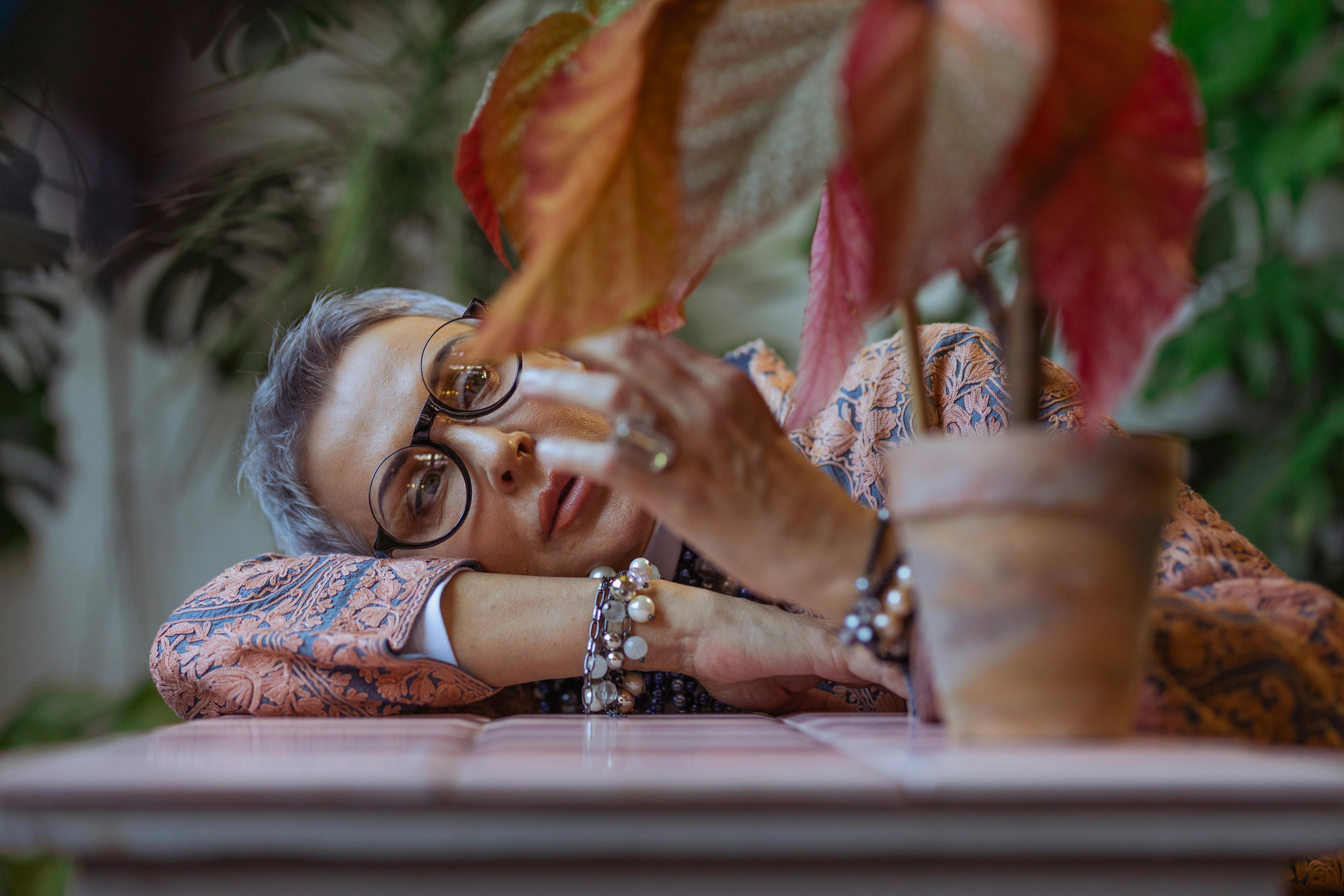 Photo Of Woman Leaning Her Head On Table · Free Stock Photo