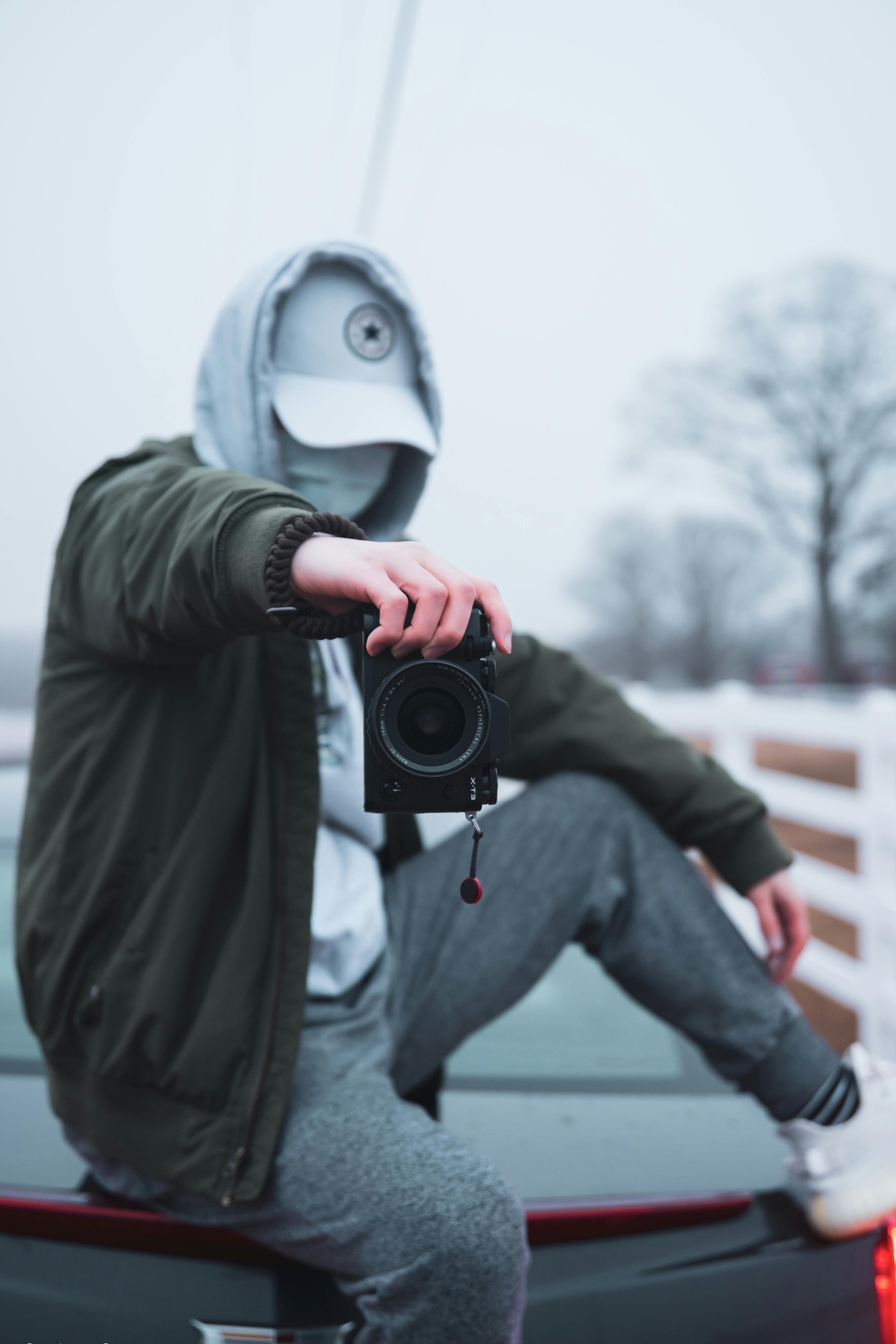Person Holding a Camera Beside the Railings · Free Stock Photo