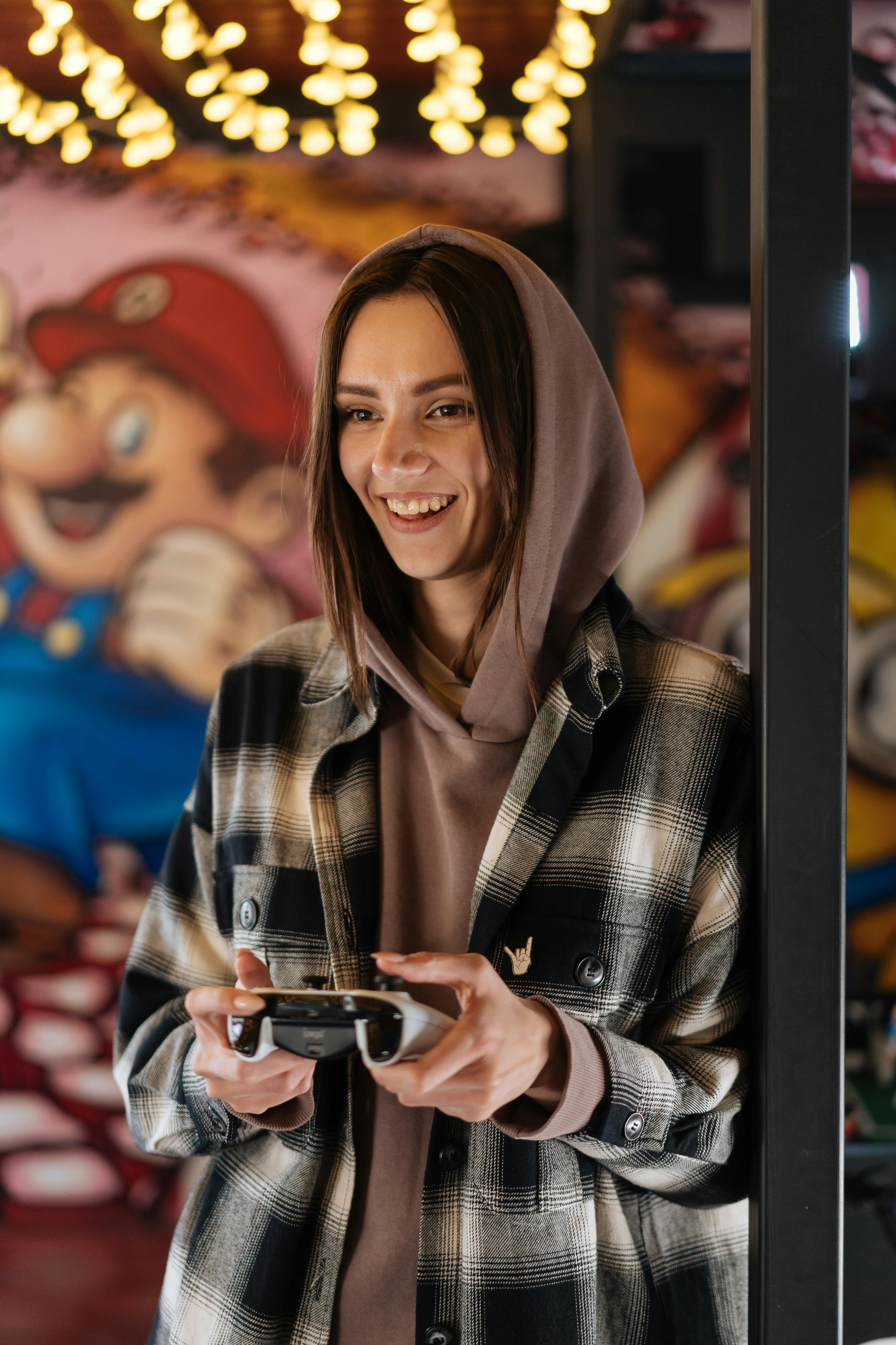 Woman In Brown Hoodie Holding A Game Controller and Playing · Free ...
