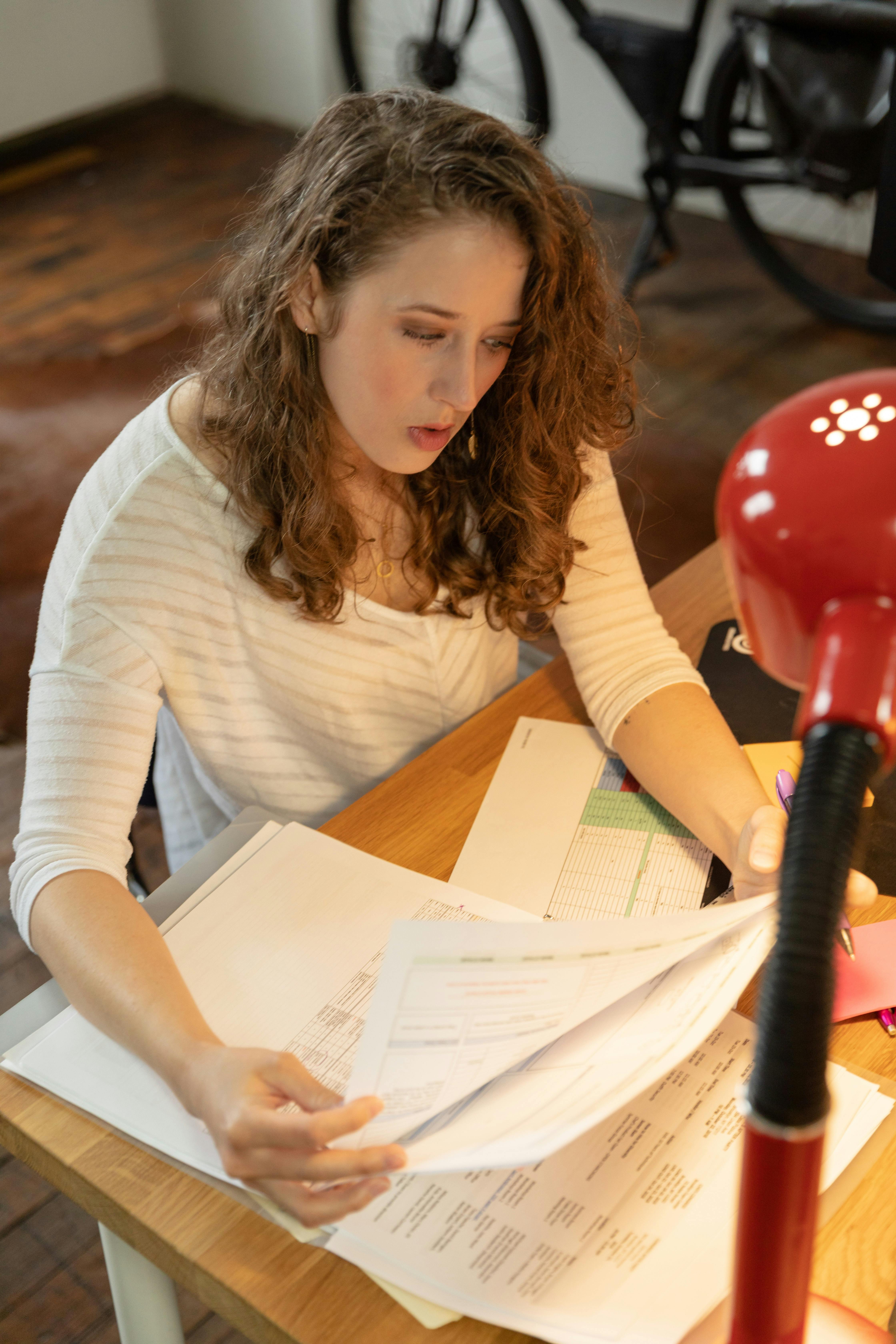 A Woman Looking at Documents · Free Stock Photo