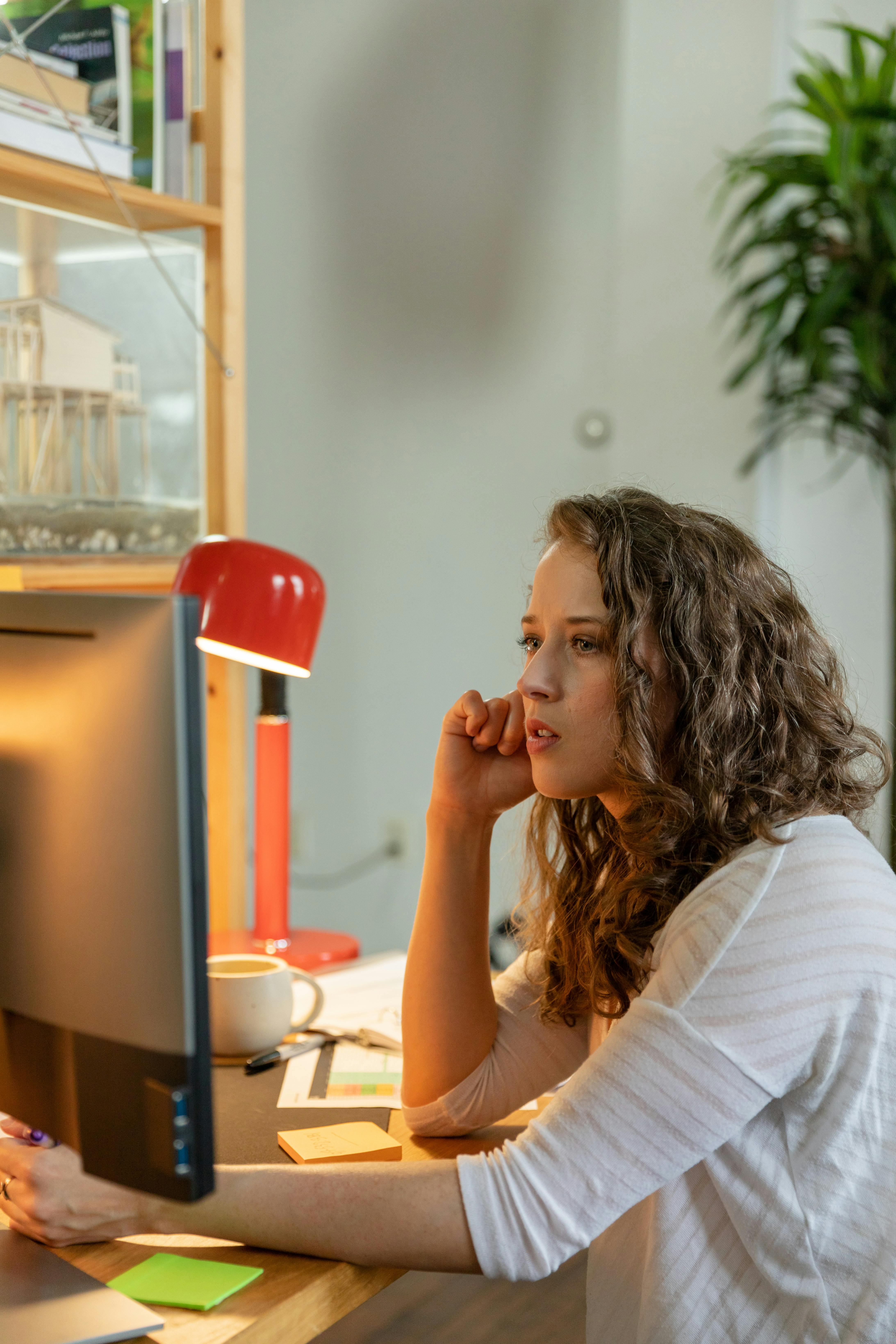 A Woman Looking at a Computer Monitor · Free Stock Photo