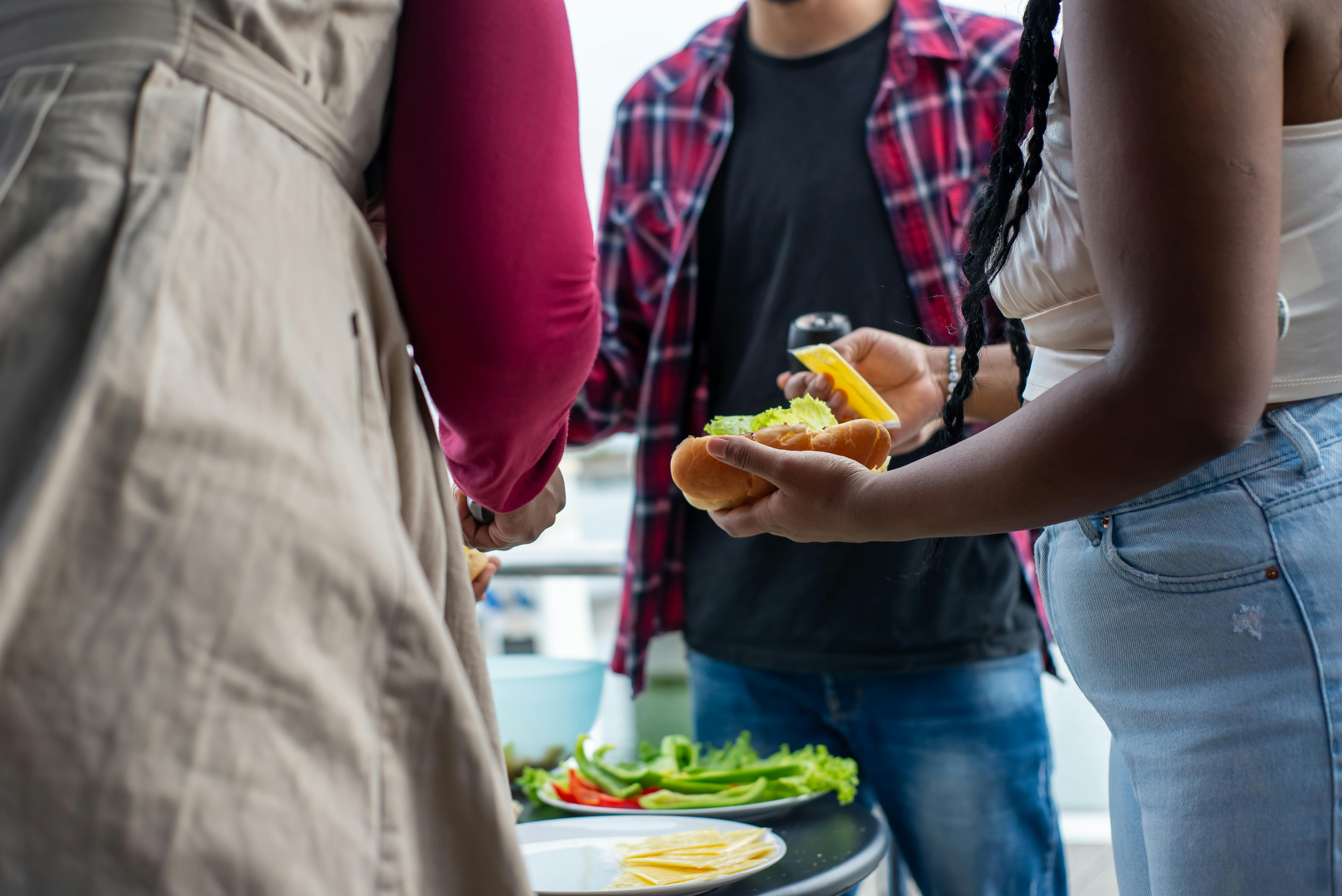 Women Holding Food over Table · Free Stock Photo