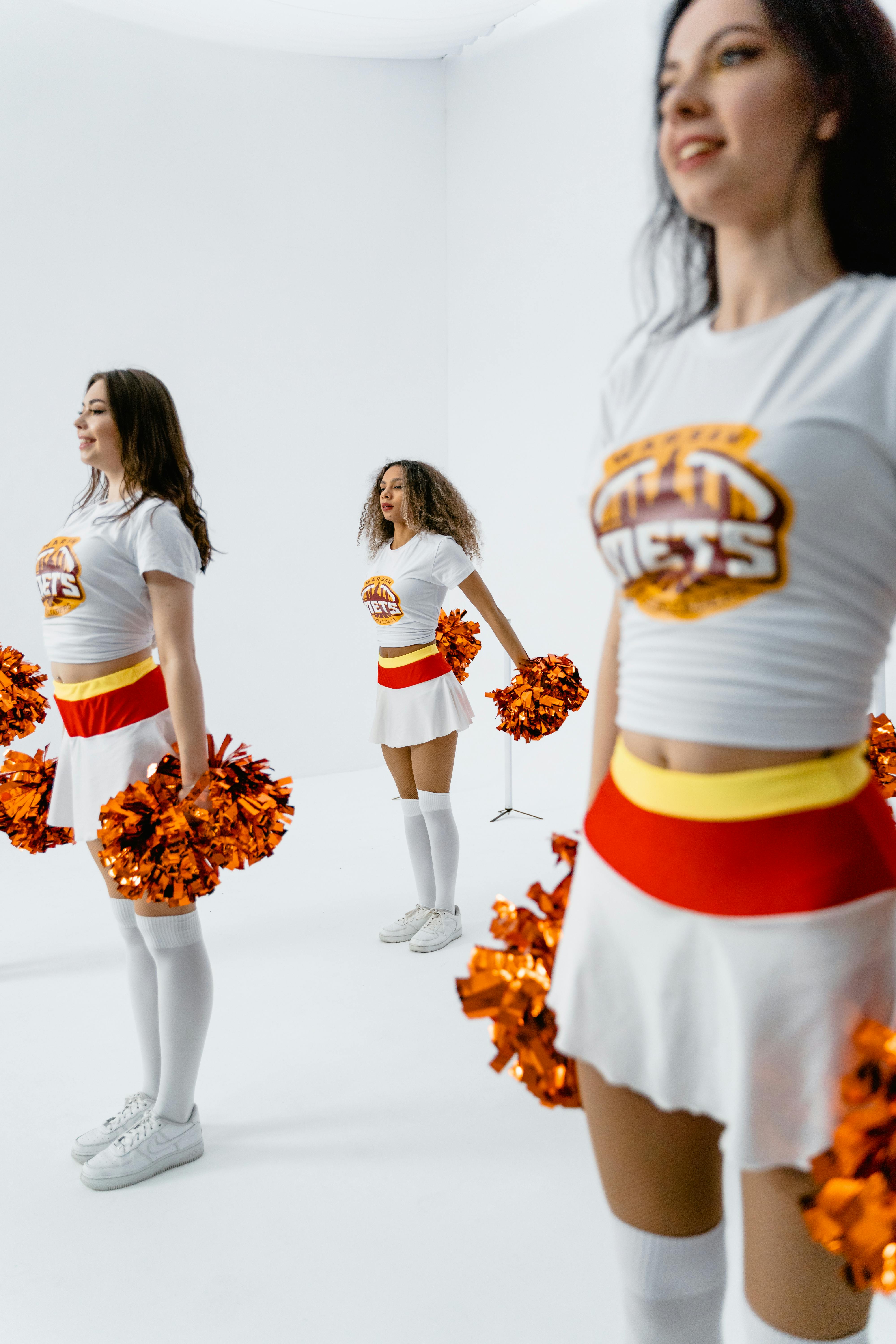 Cheerleaders Holding Cheering Pompoms · Free Stock Photo