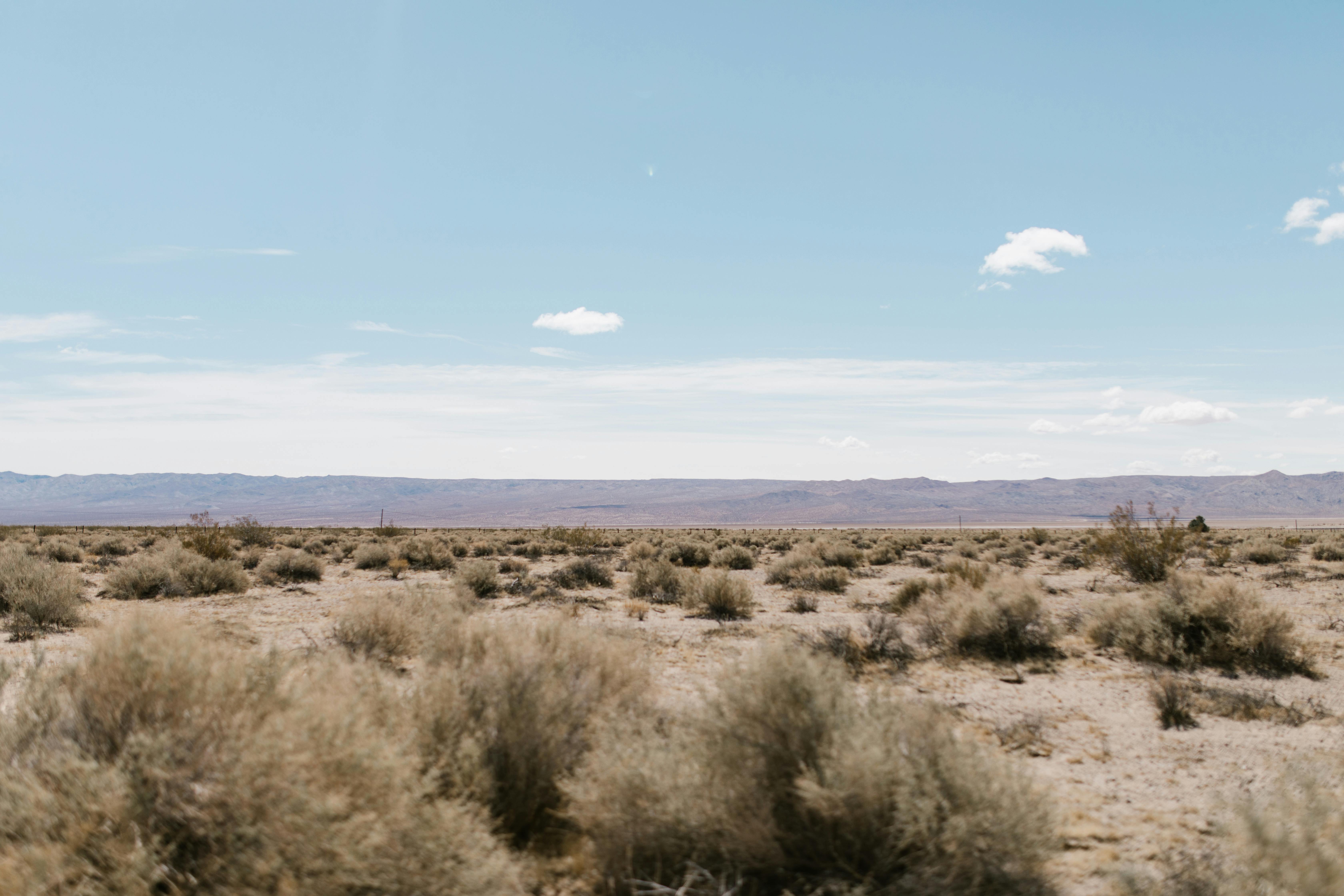 Brown Sandy Field Under Blue and White Cloudy Sky · Free Stock Photo