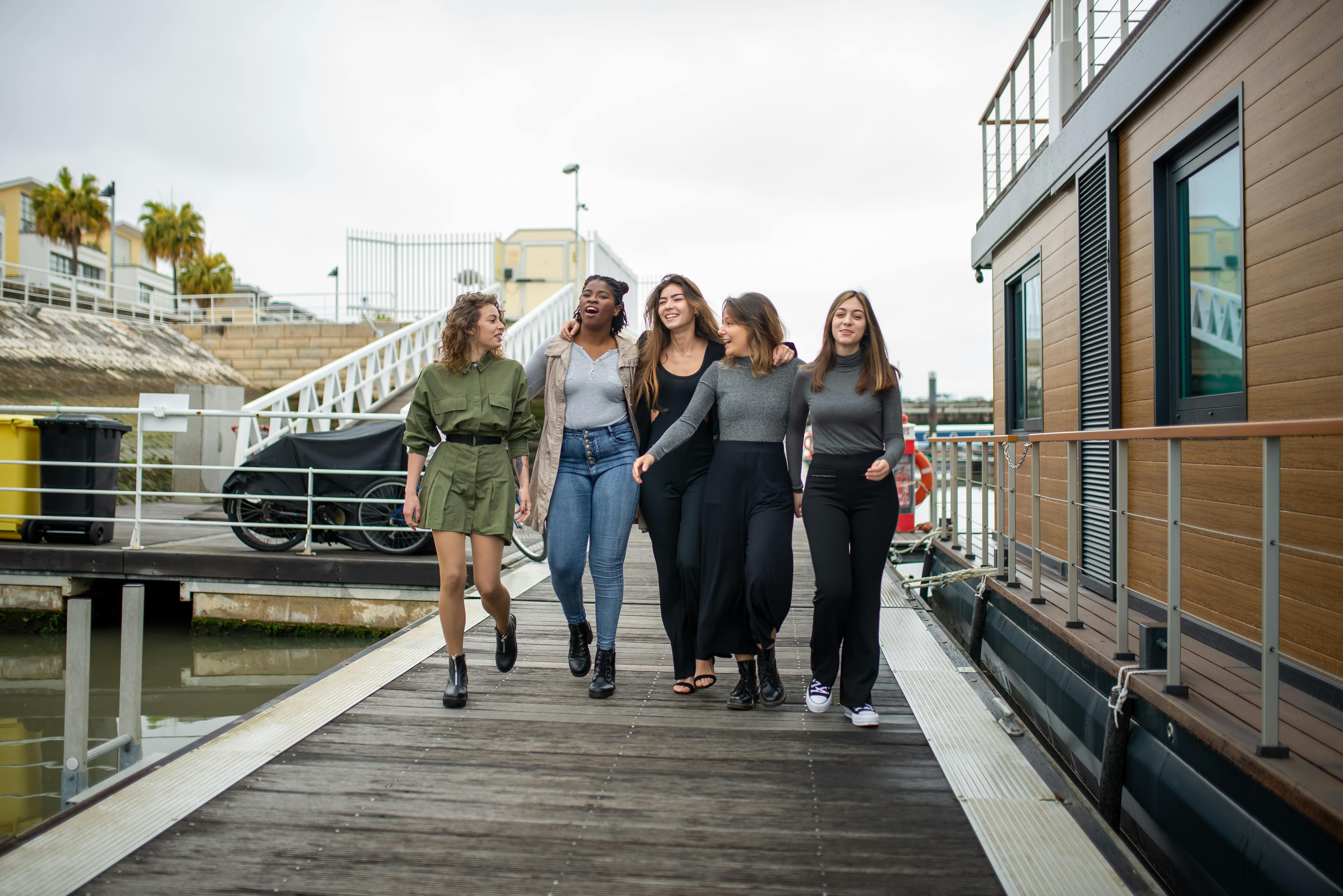 Group of Women Walking on Boardwalk · Free Stock Photo