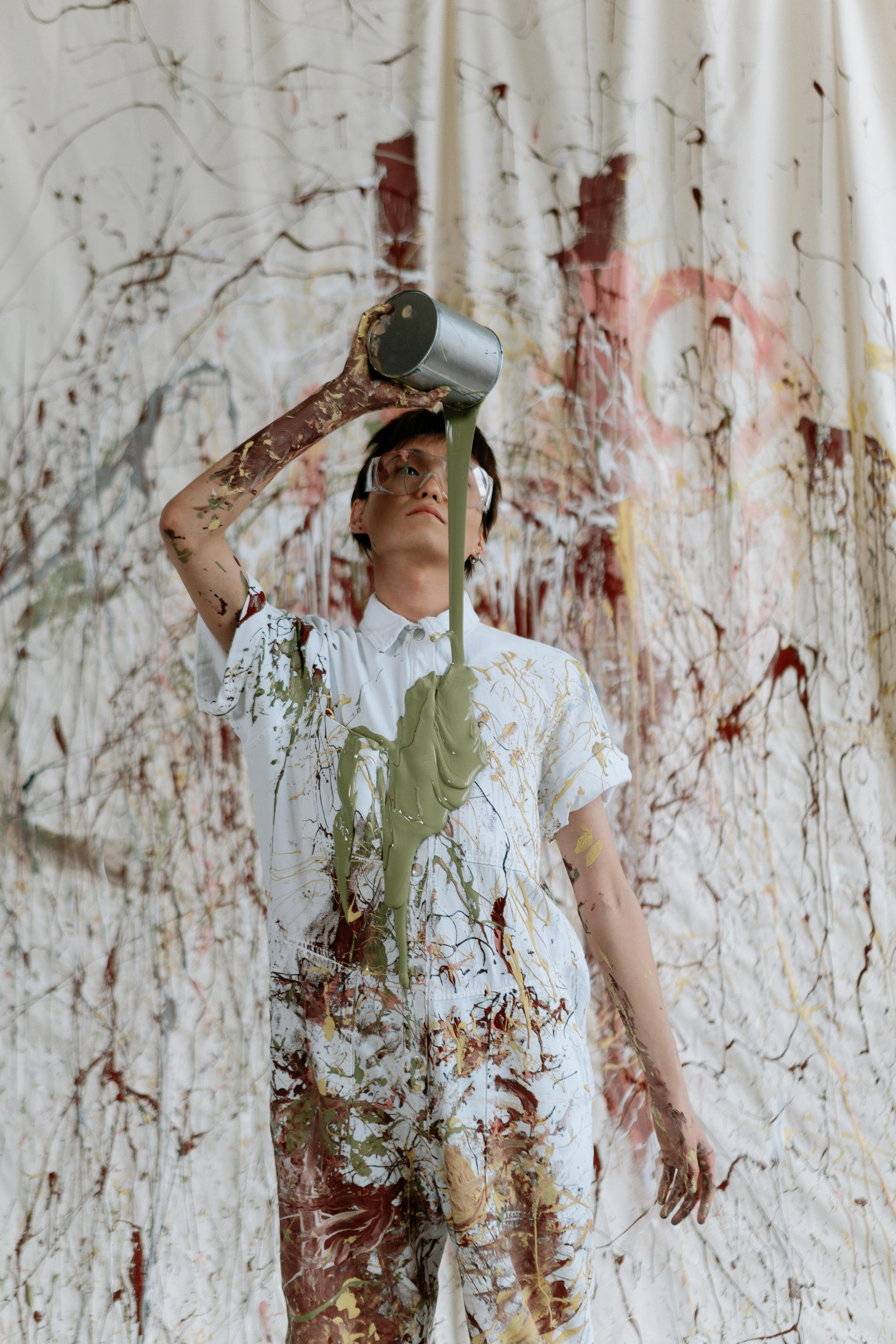 A Man Pouring Paint on His Chest · Free Stock Photo