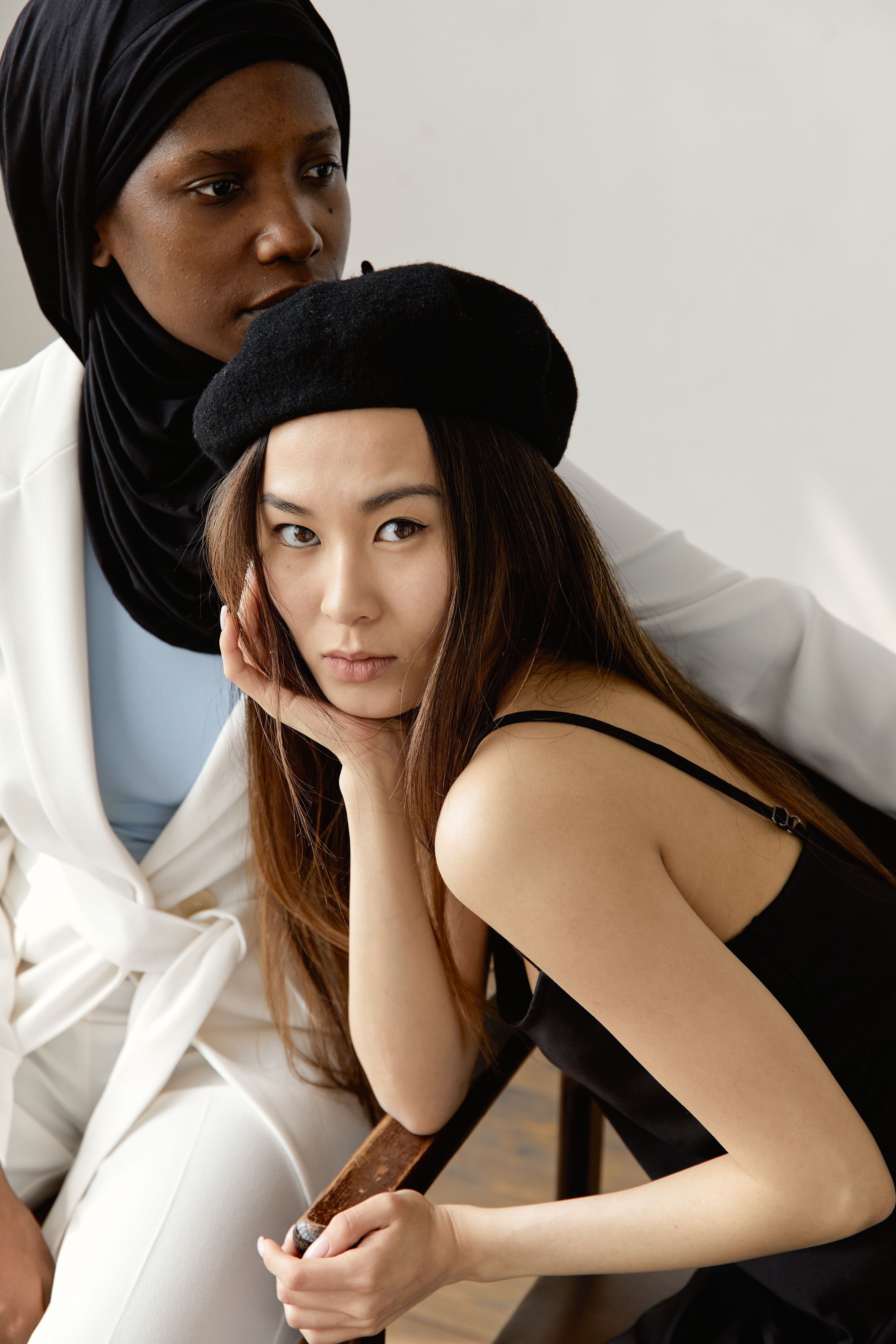 Woman with a Beret Posing Near a Woman with a Hijab · Free Stock Photo