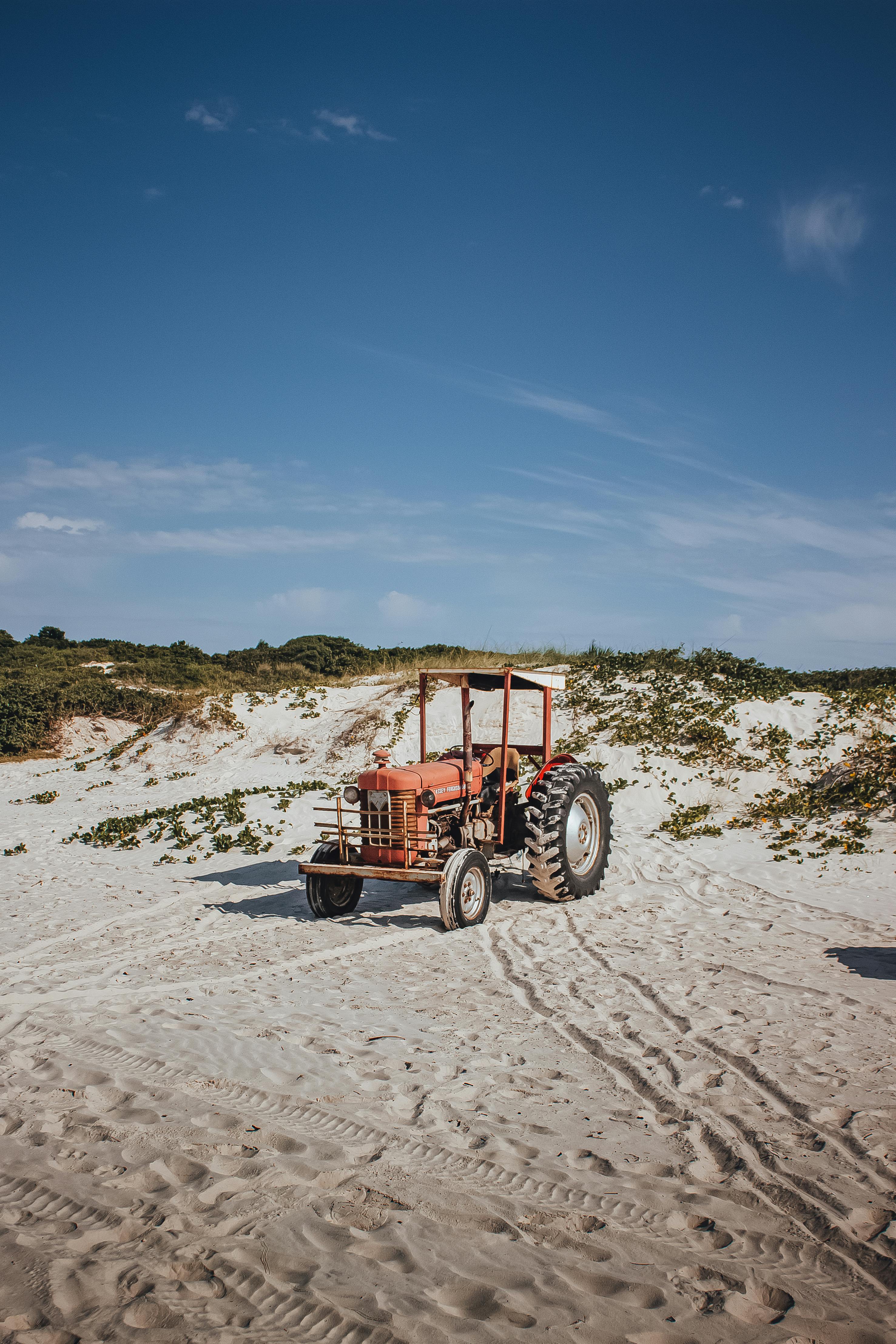 Red Tractor on the Sand Under Blue Sky · Free Stock Photo