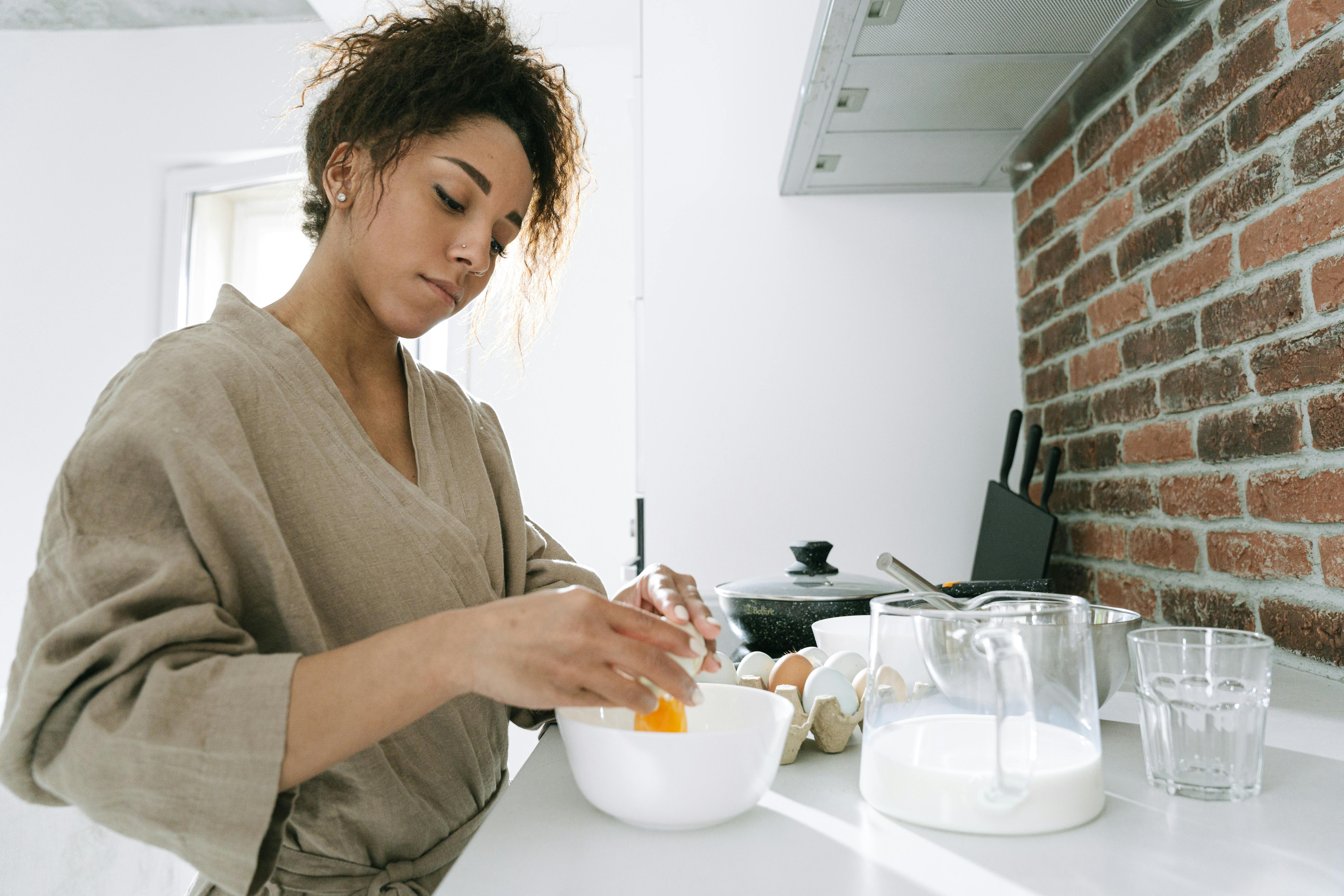 A Woman Cooking at the Kitchen · Free Stock Photo