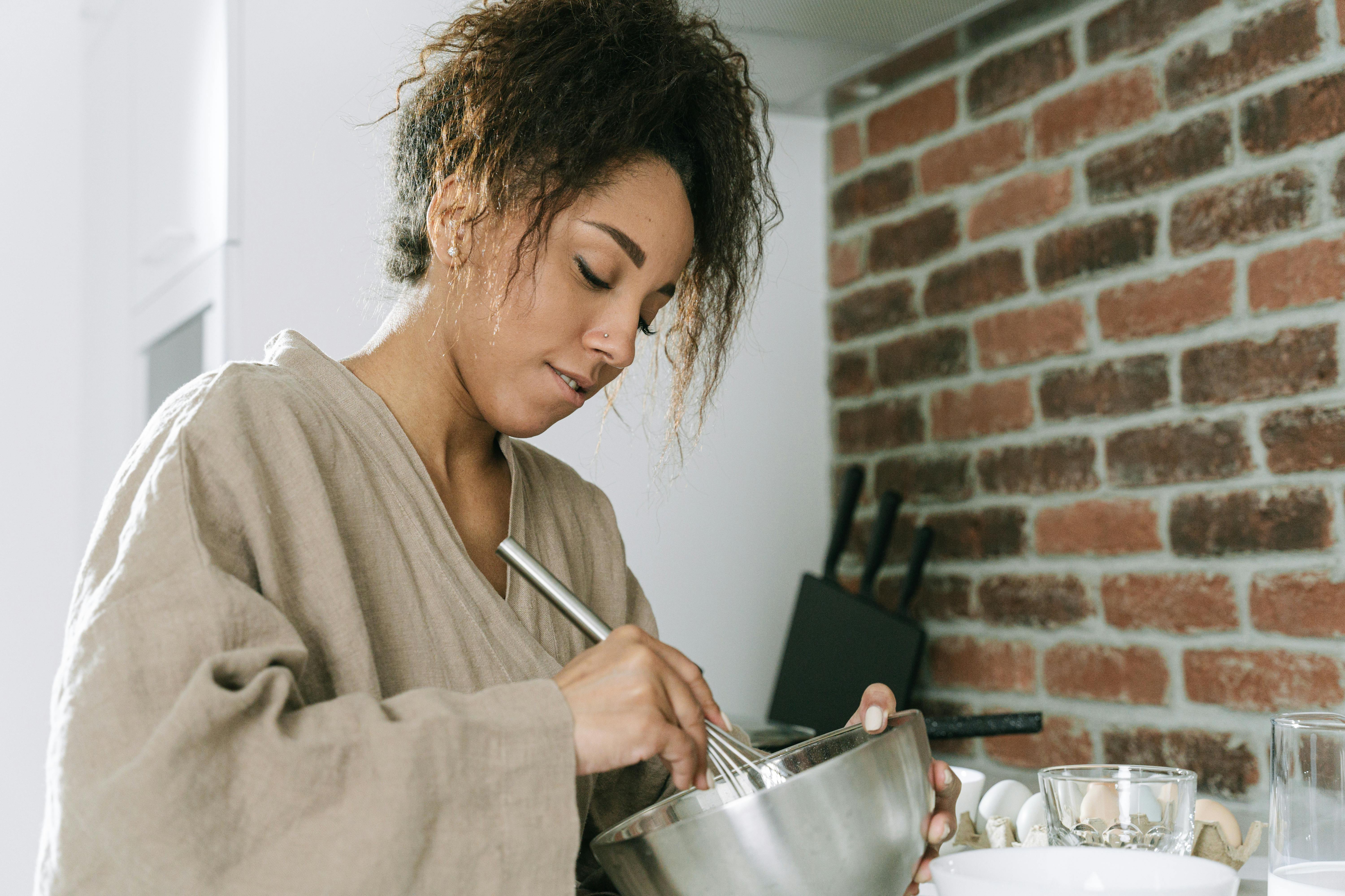 A Woman Cooking at the Kitchen · Free Stock Photo