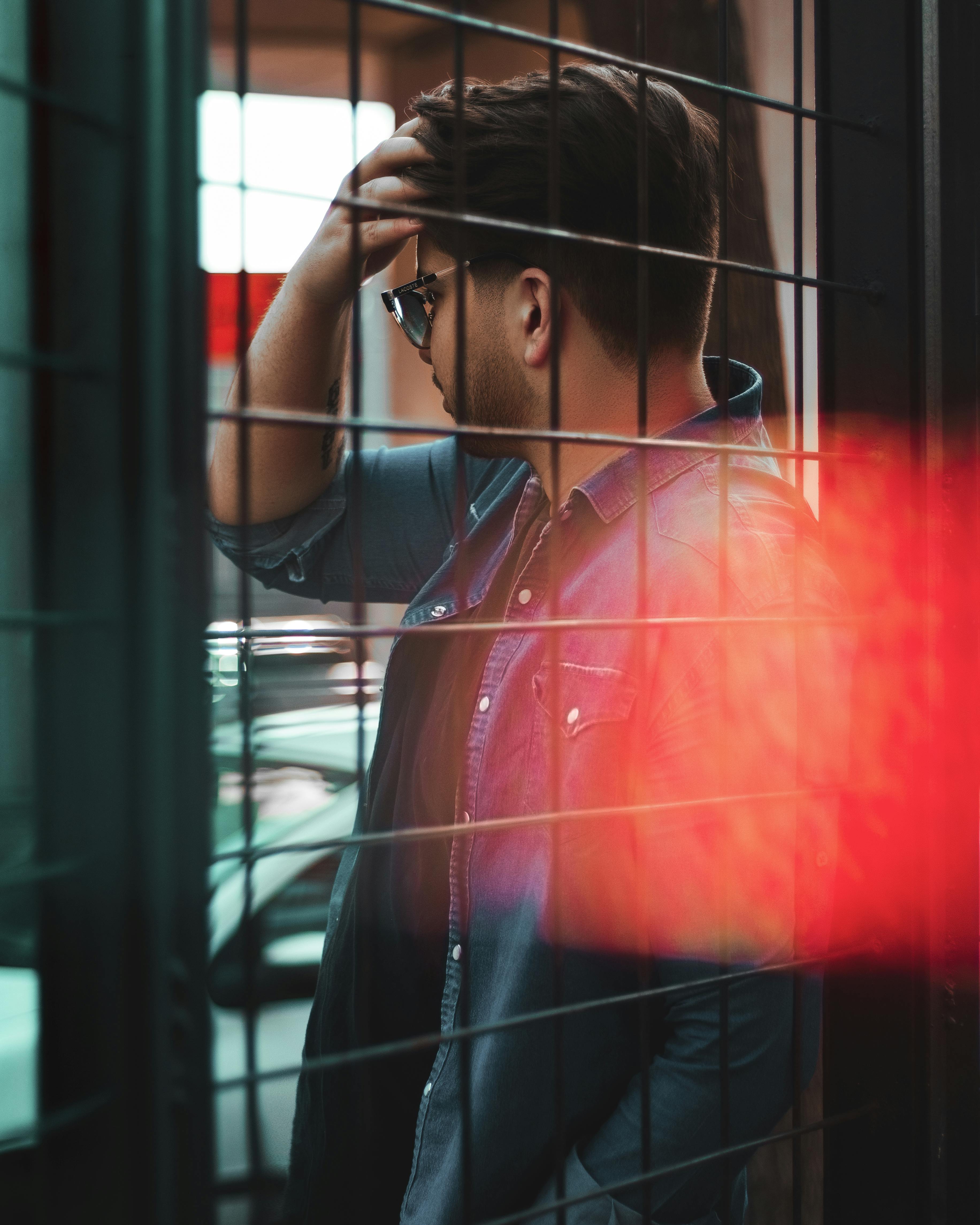 A Man Covering his Face with Blue Denim Jacket · Free Stock Photo