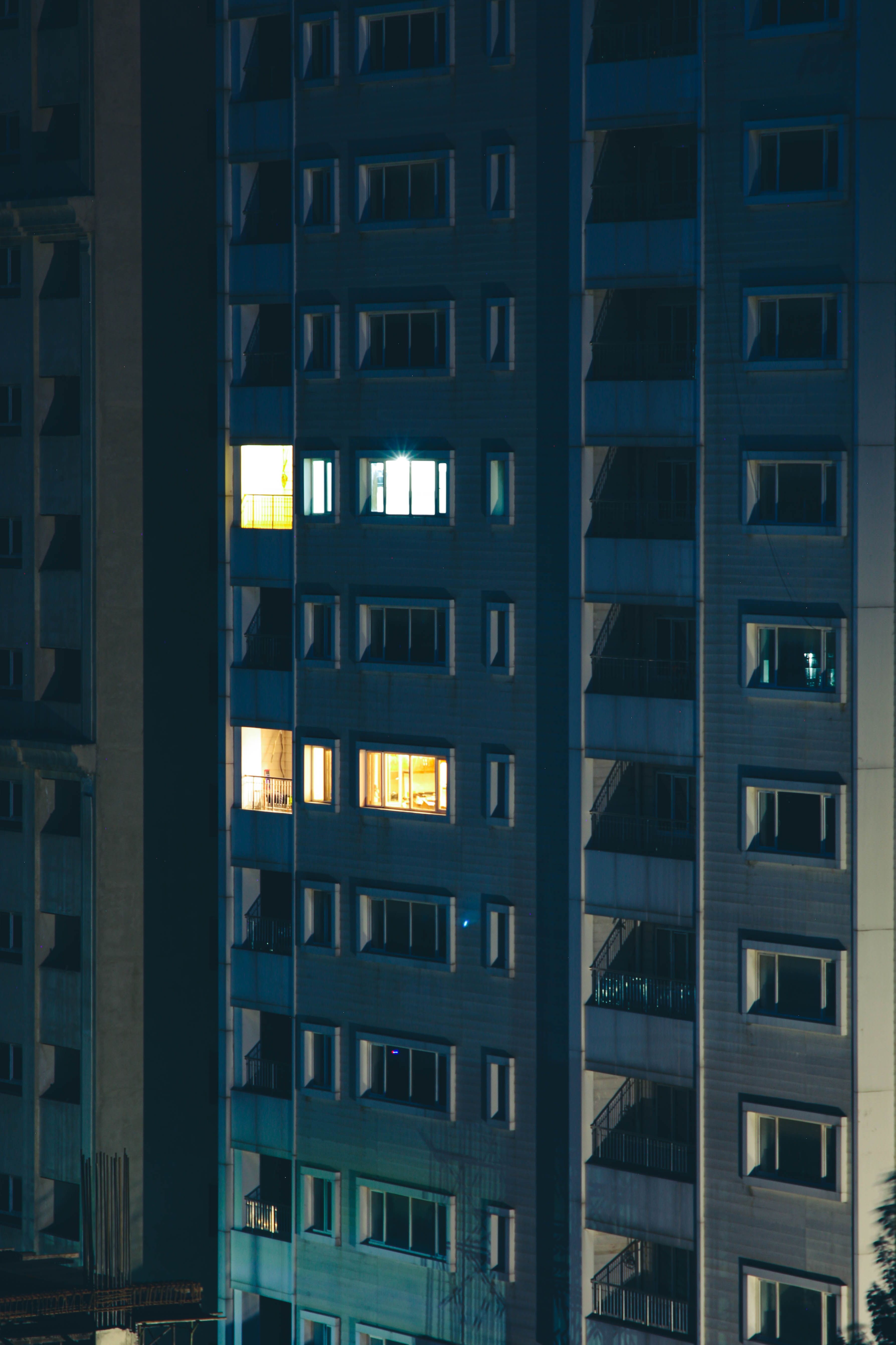 Brown Concrete Building with Illuminated Windows During Night Time ...