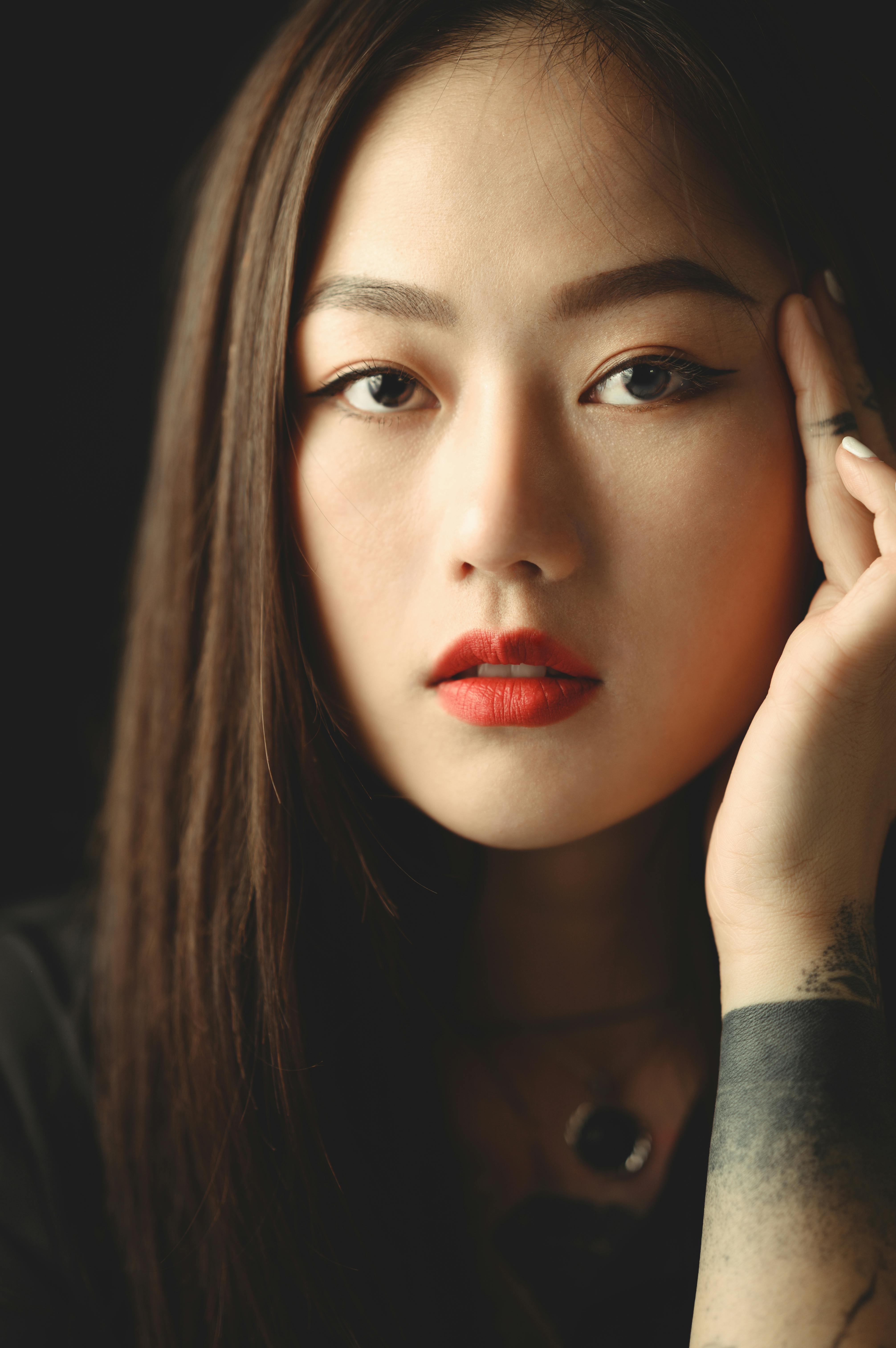 A Beautiful Woman with Her Hand on Her Head · Free Stock Photo