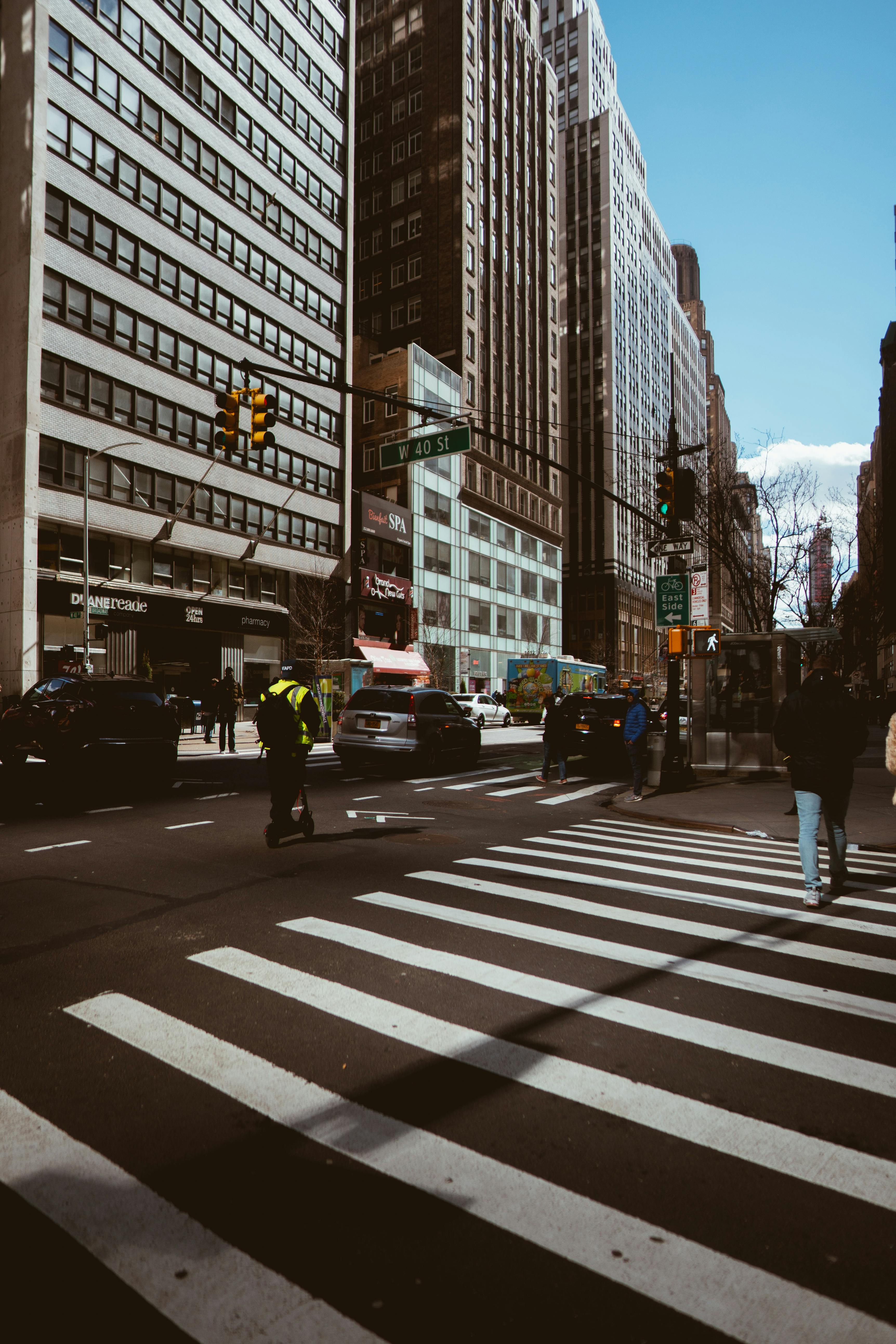 Person Walking on Pedestrian Lane · Free Stock Photo