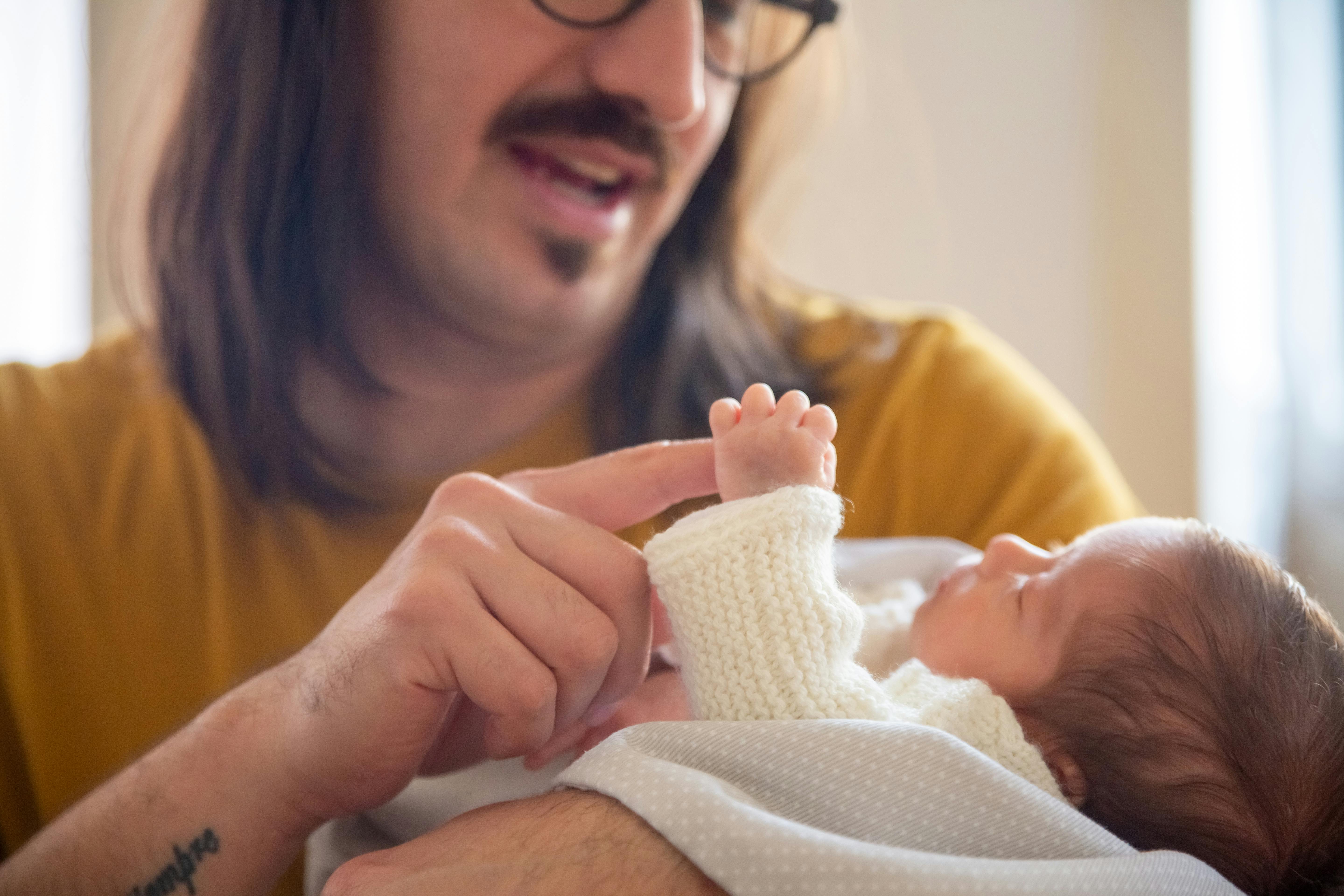 A Person Carrying a Baby · Free Stock Photo