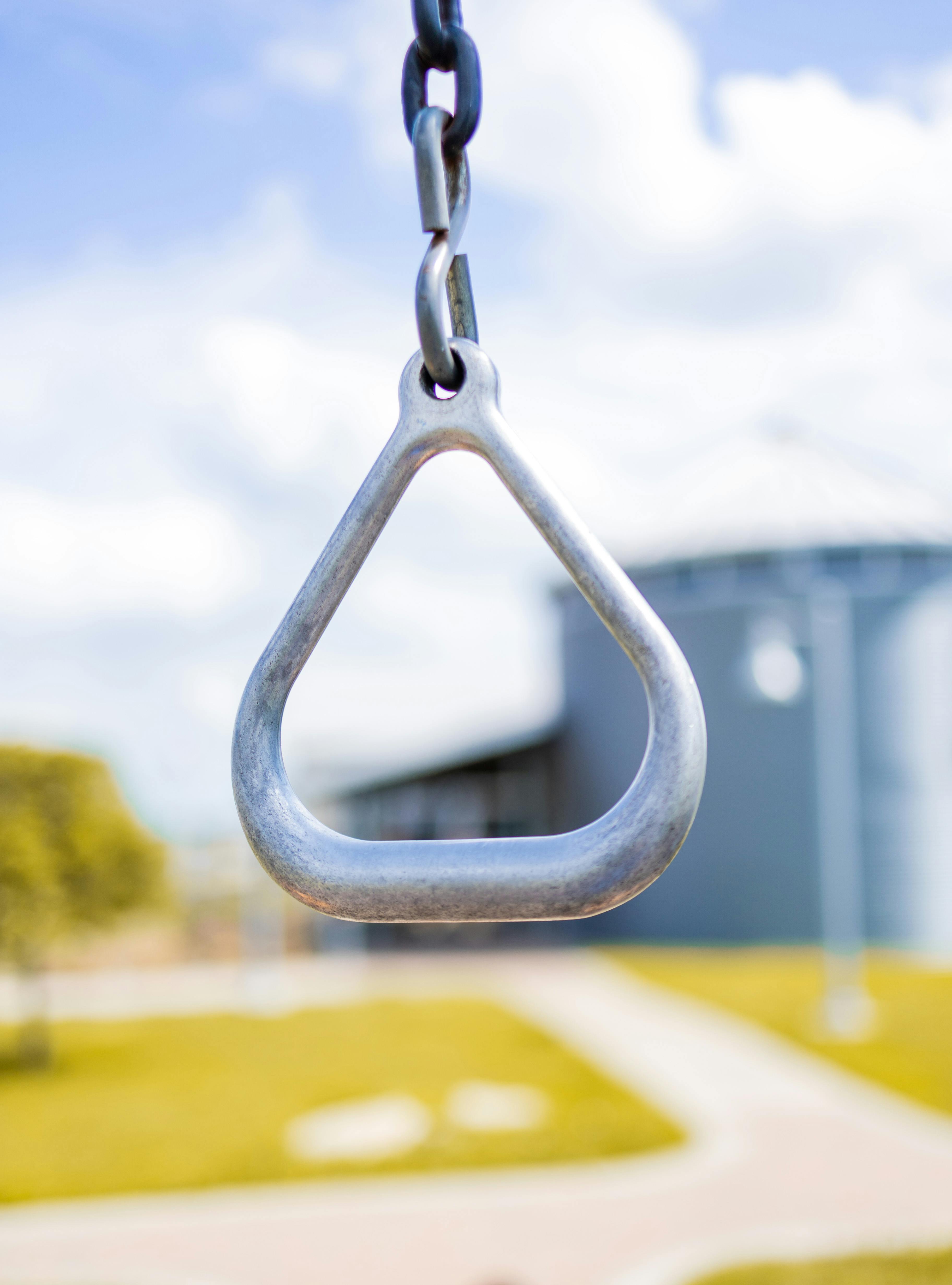 A Hanging Metal Triangle Handle on a Chain · Free Stock Photo