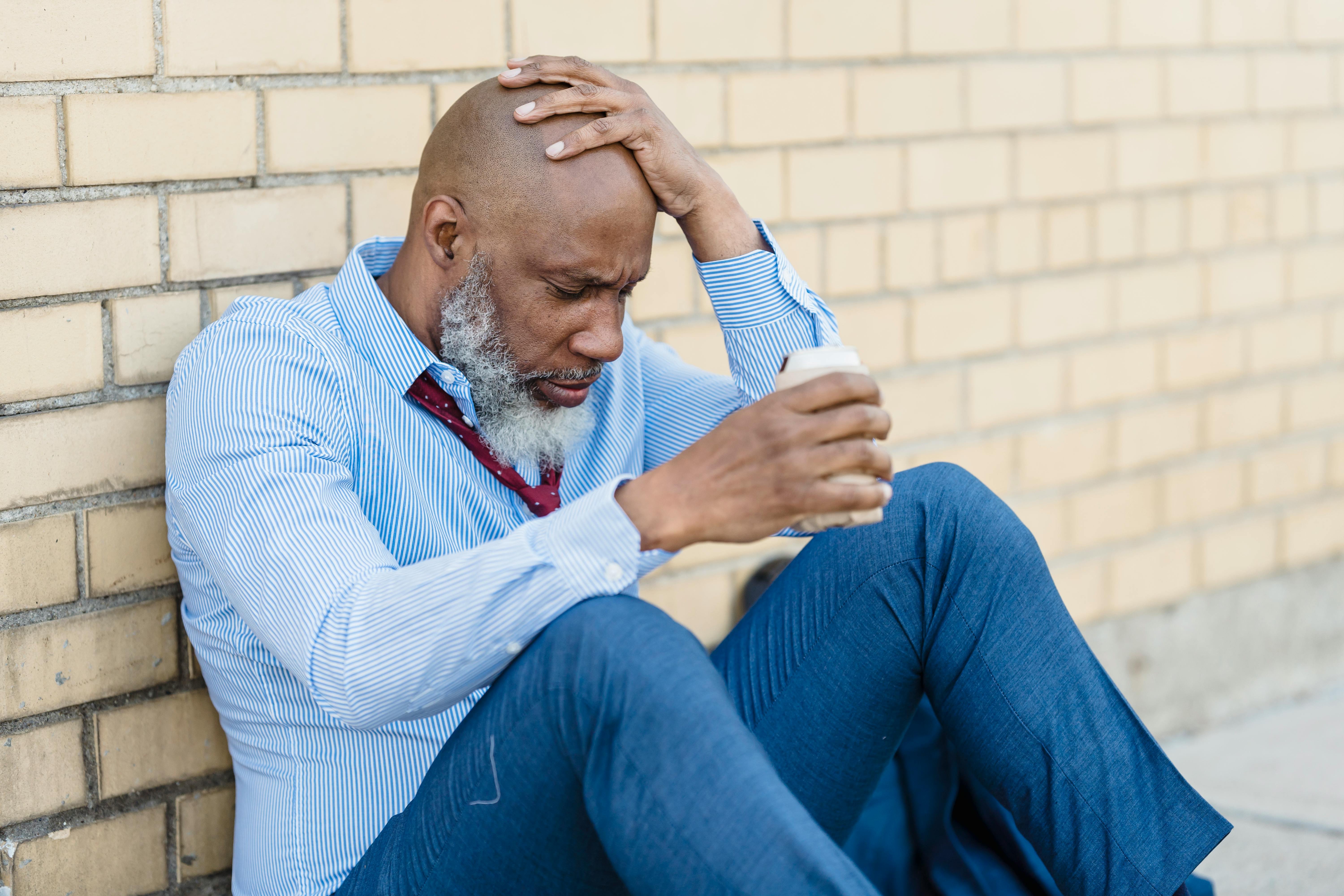 Alcoholic in Suit Sitting on Street Drinking Beer · Free Stock Photo
