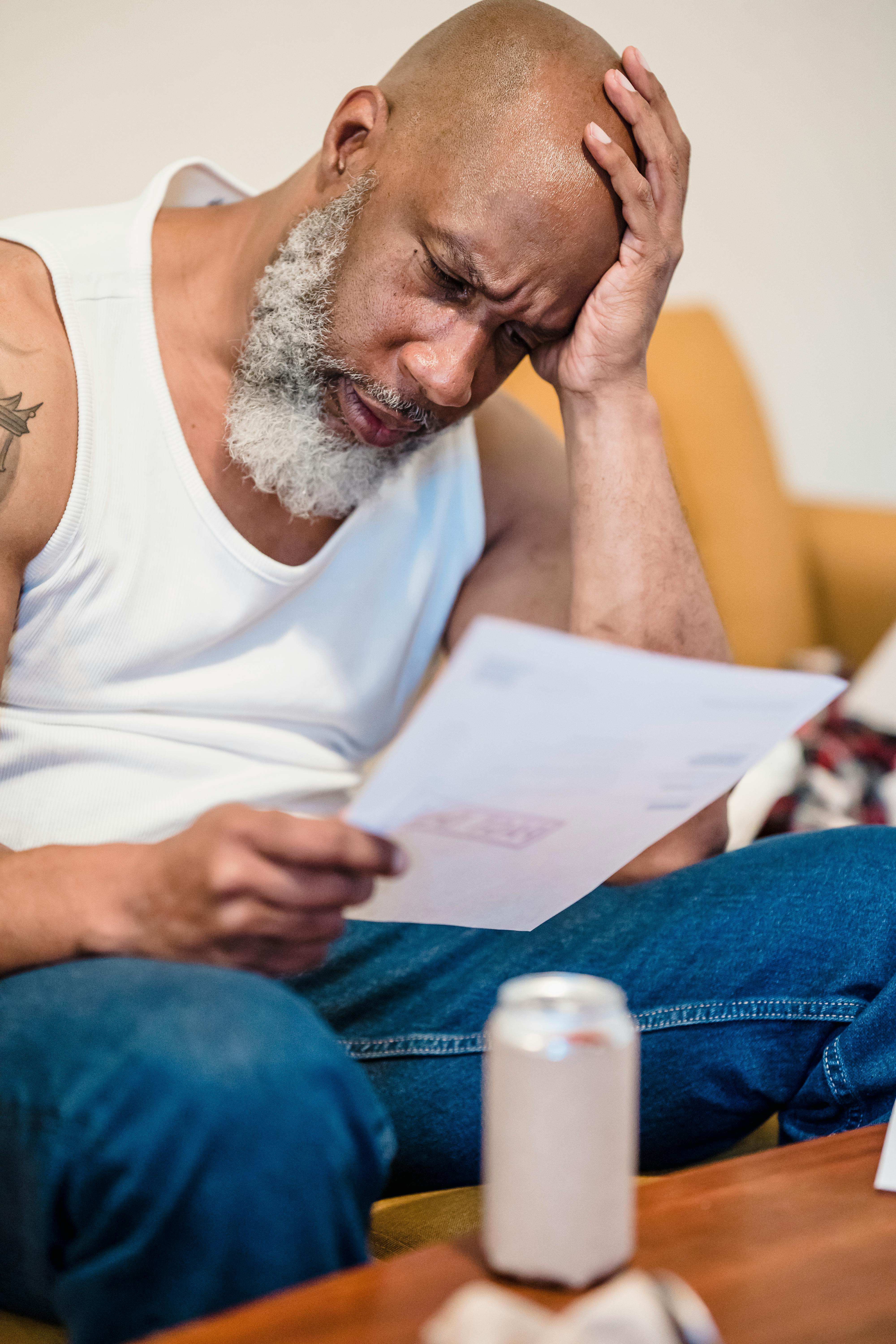 Stressed Old Man Reading Bad News in Letter · Free Stock Photo