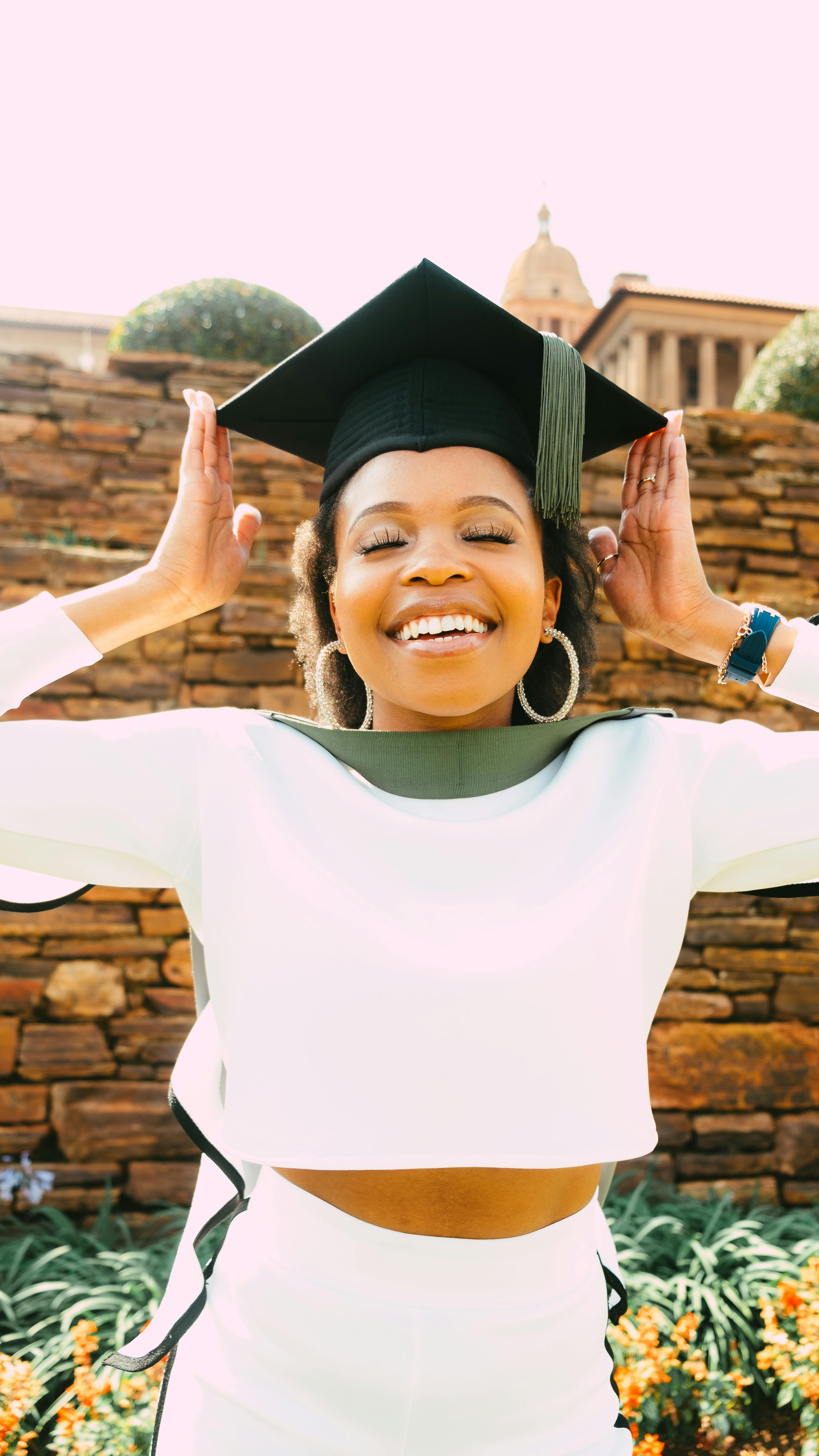 Happy College Graduate in Graduation Attire · Free Stock Photo