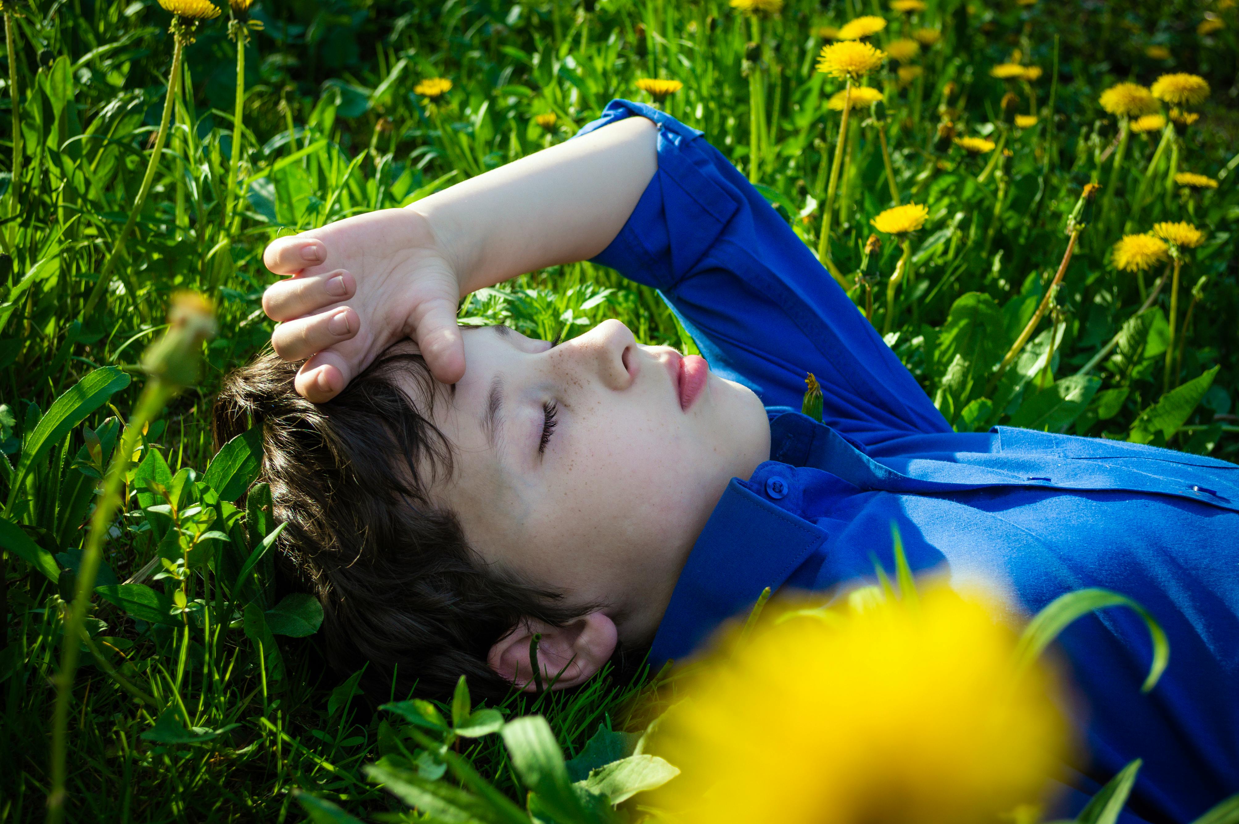 Boy Lying on Bed Closed Eyes While Smiling · Free Stock Photo