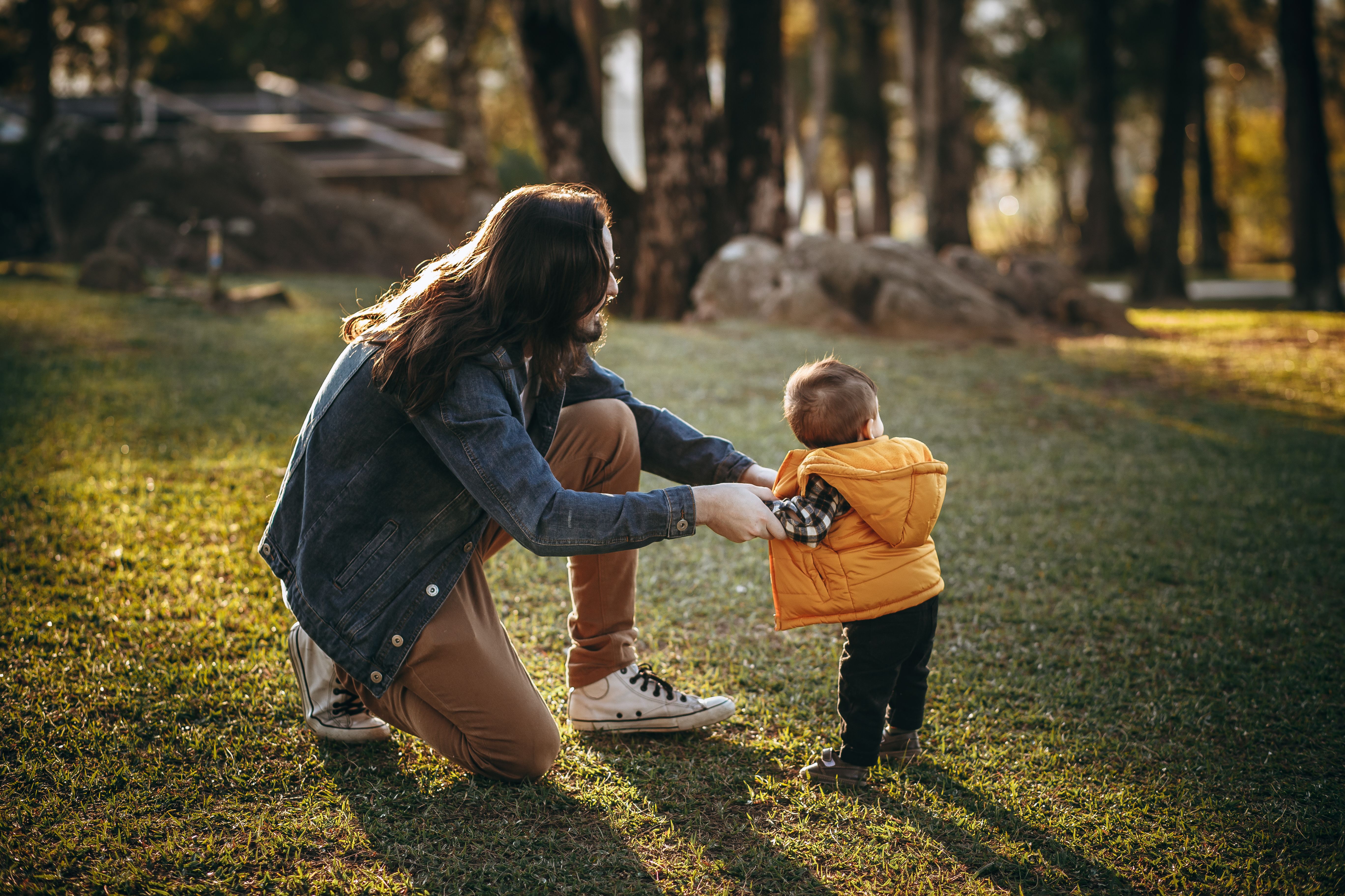 Father and son looking away in park · Free Stock Photo