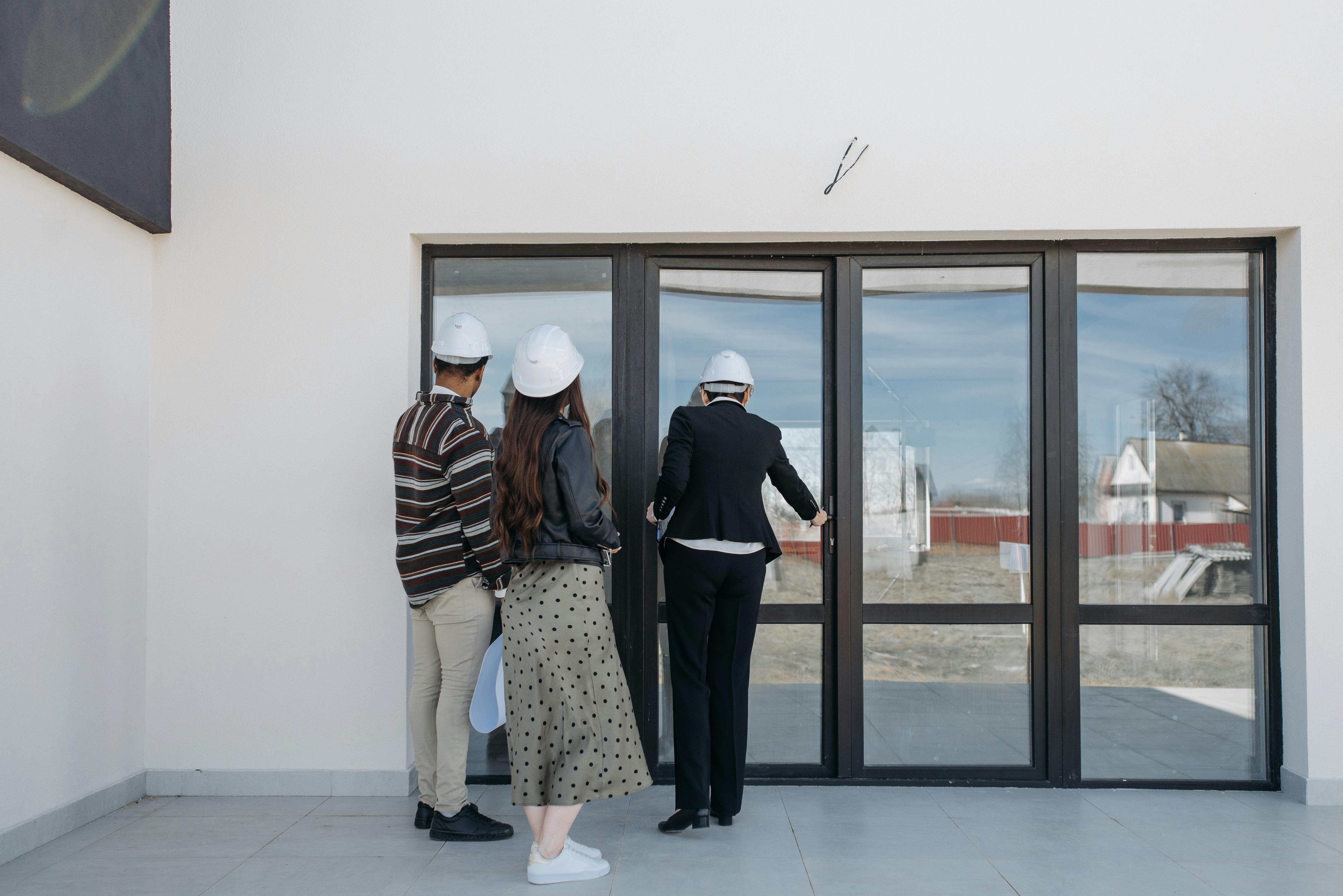 People Standing Beside the Glass Window · Free Stock Photo