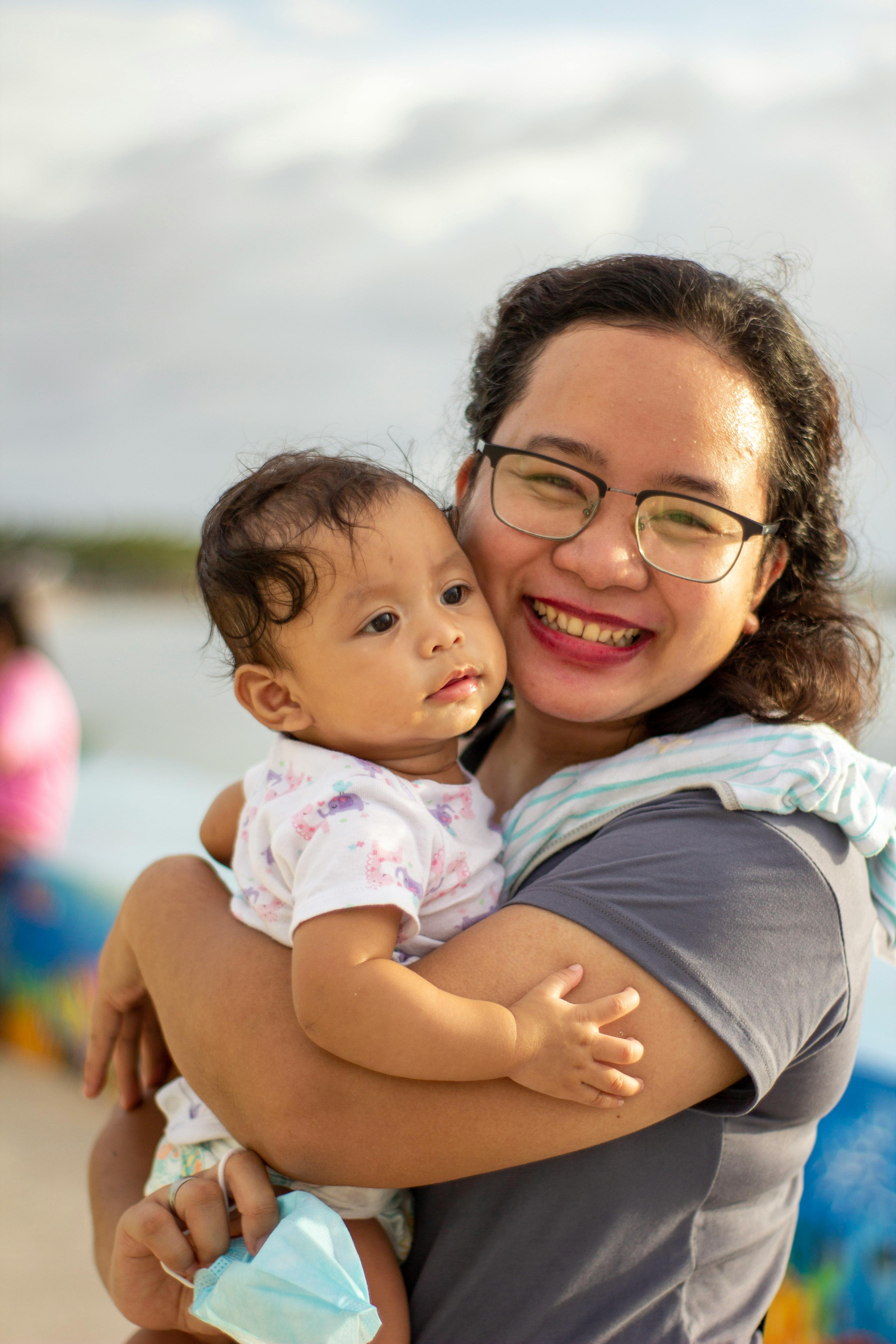 Woman Embracing Baby Daughter · Free Stock Photo