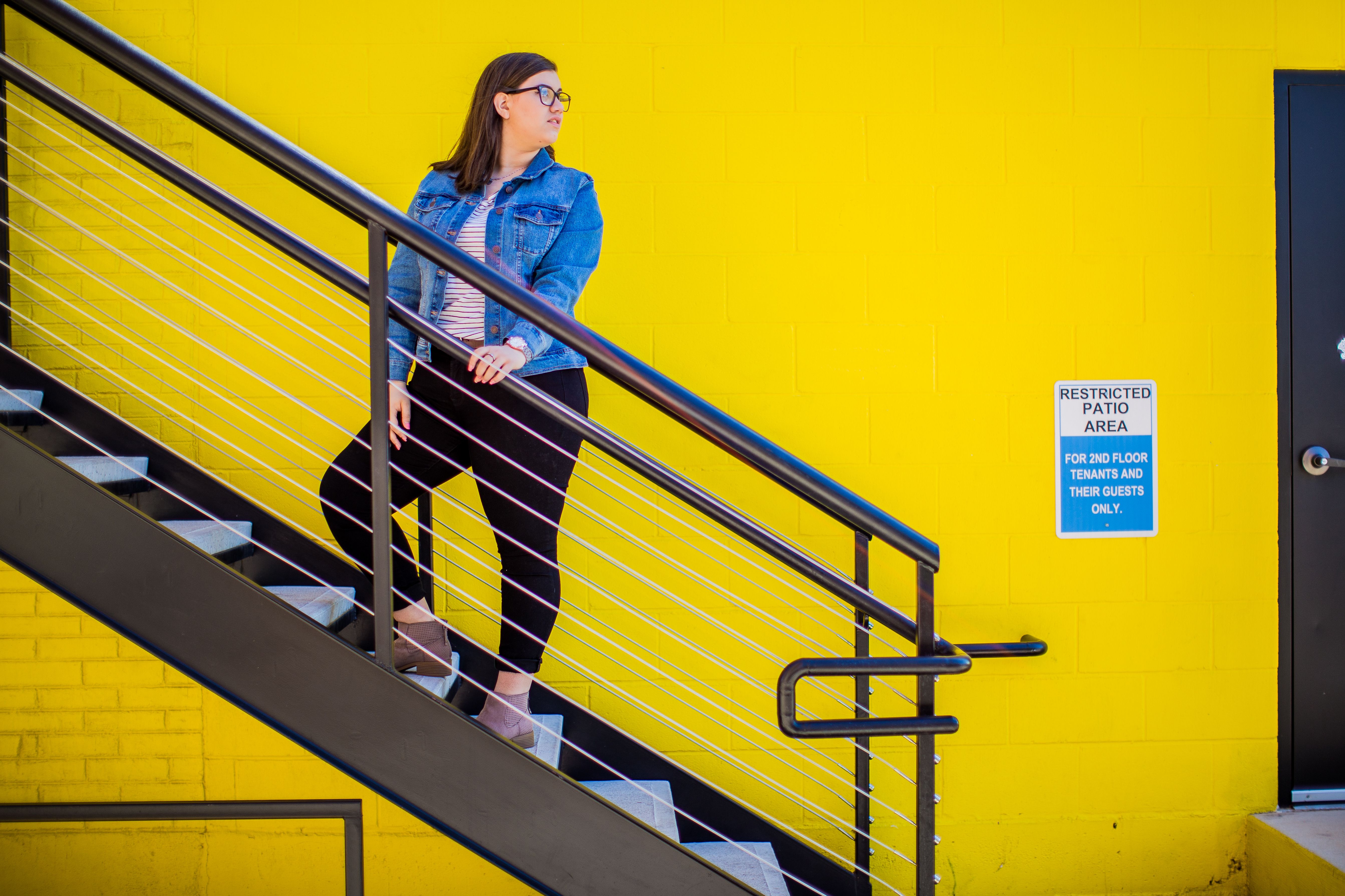 Woman in Denim Jacket Standing on the Stairs · Free Stock Photo