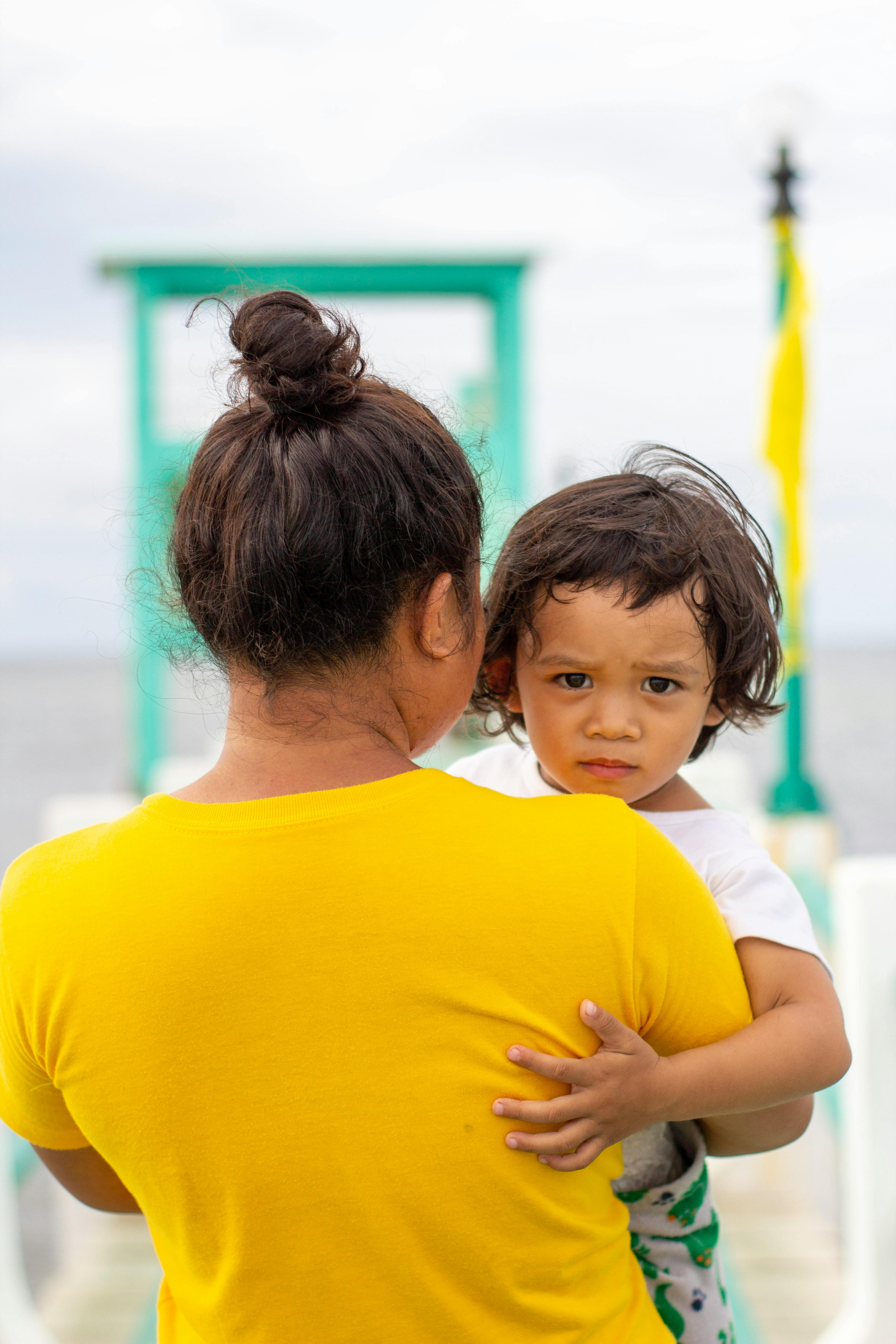 Little Boy Carried by His Mother · Free Stock Photo