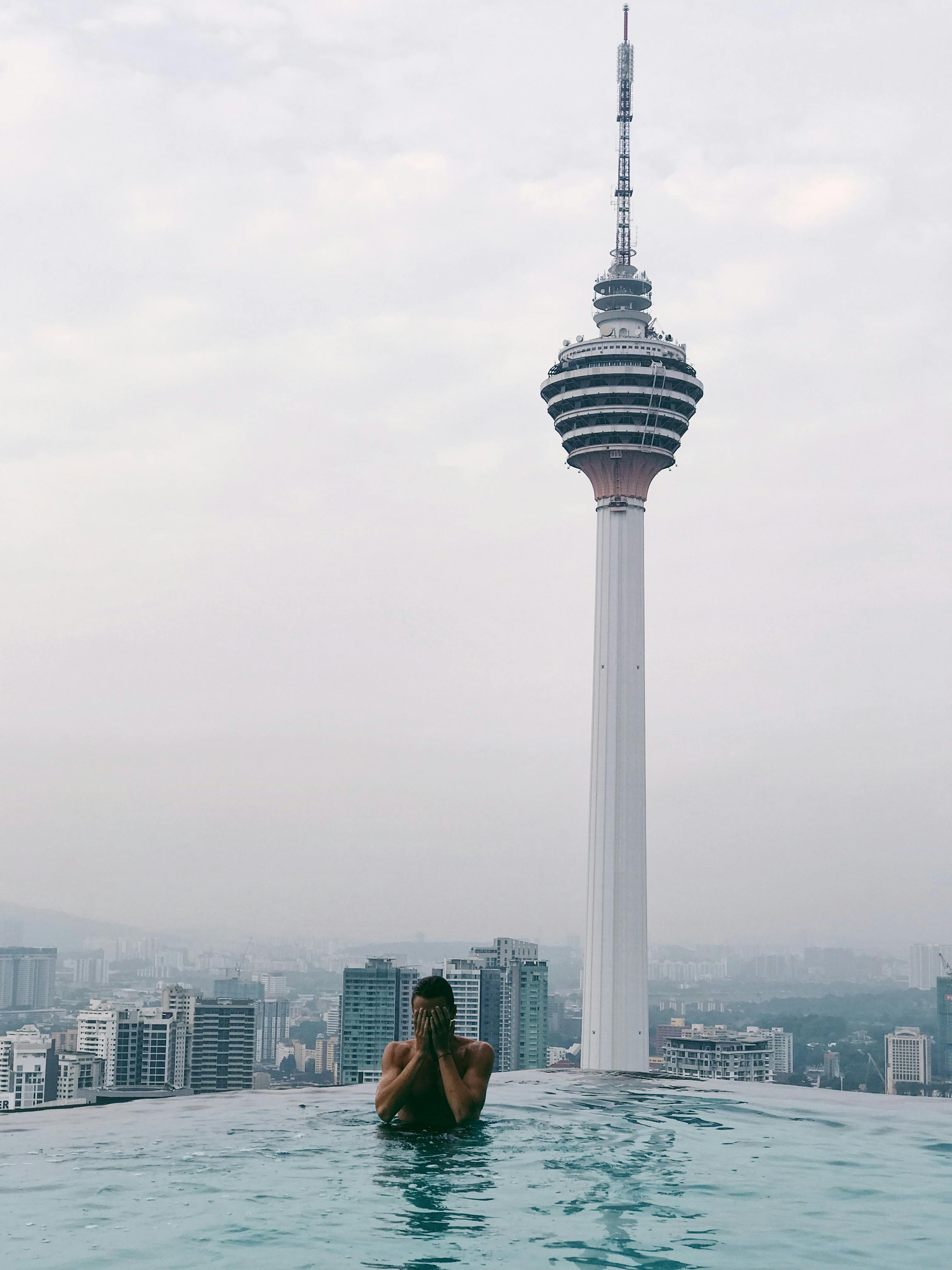 Man Swimming in an Infinity Pool · Free Stock Photo
