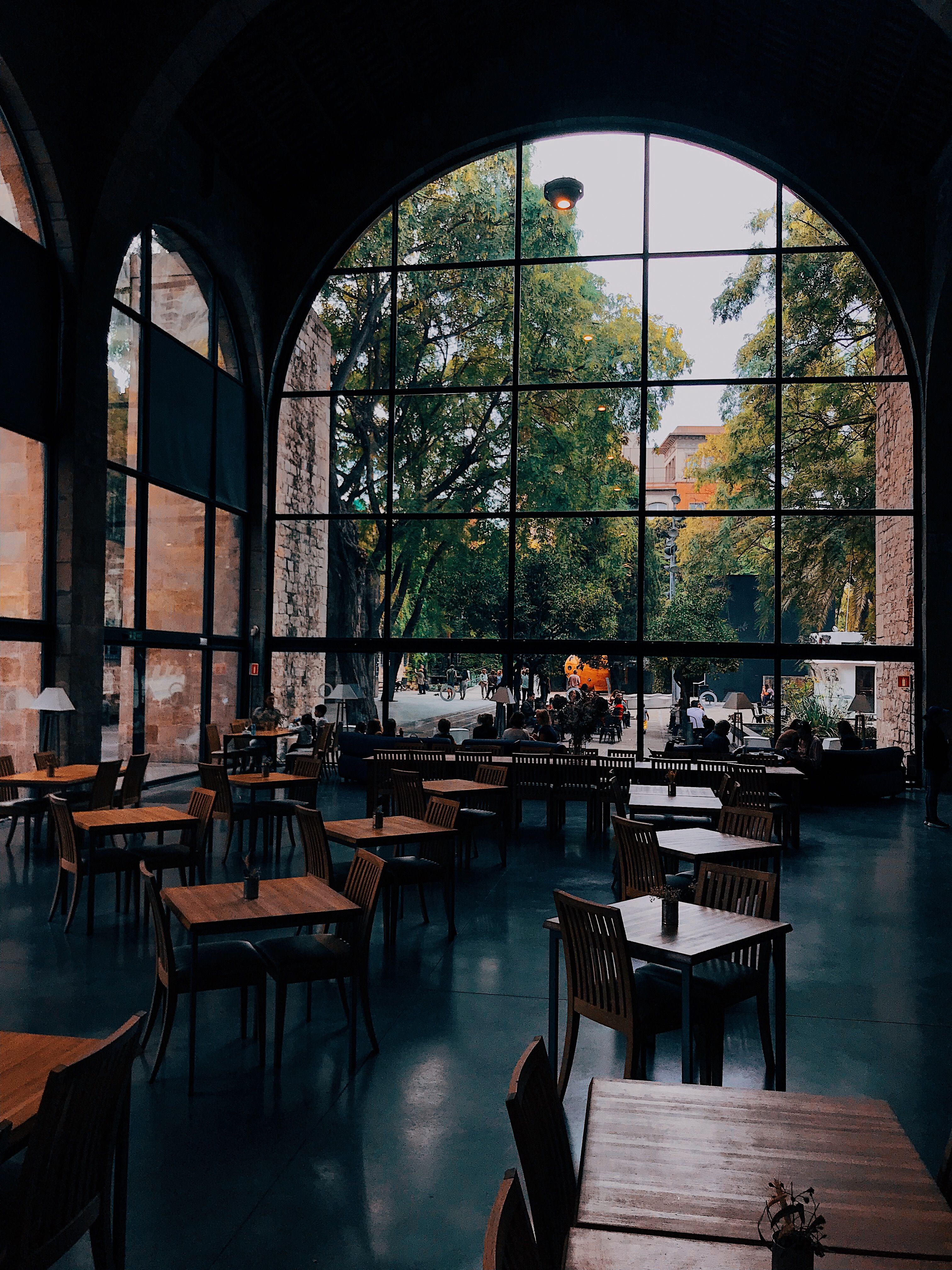 A Wooden Table and Chairs Inside the Restaurant · Free Stock Photo