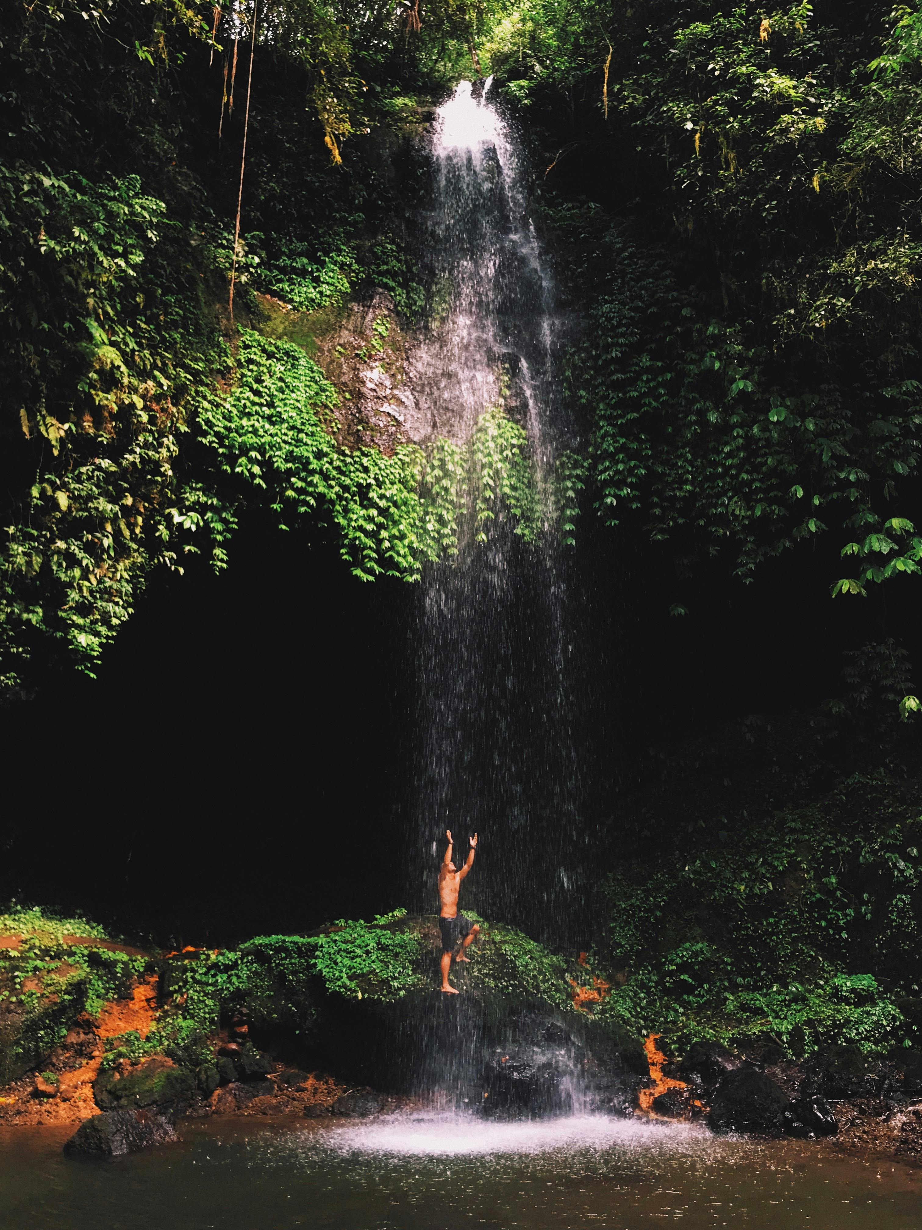 A Person Standing Under the Waterfall · Free Stock Photo