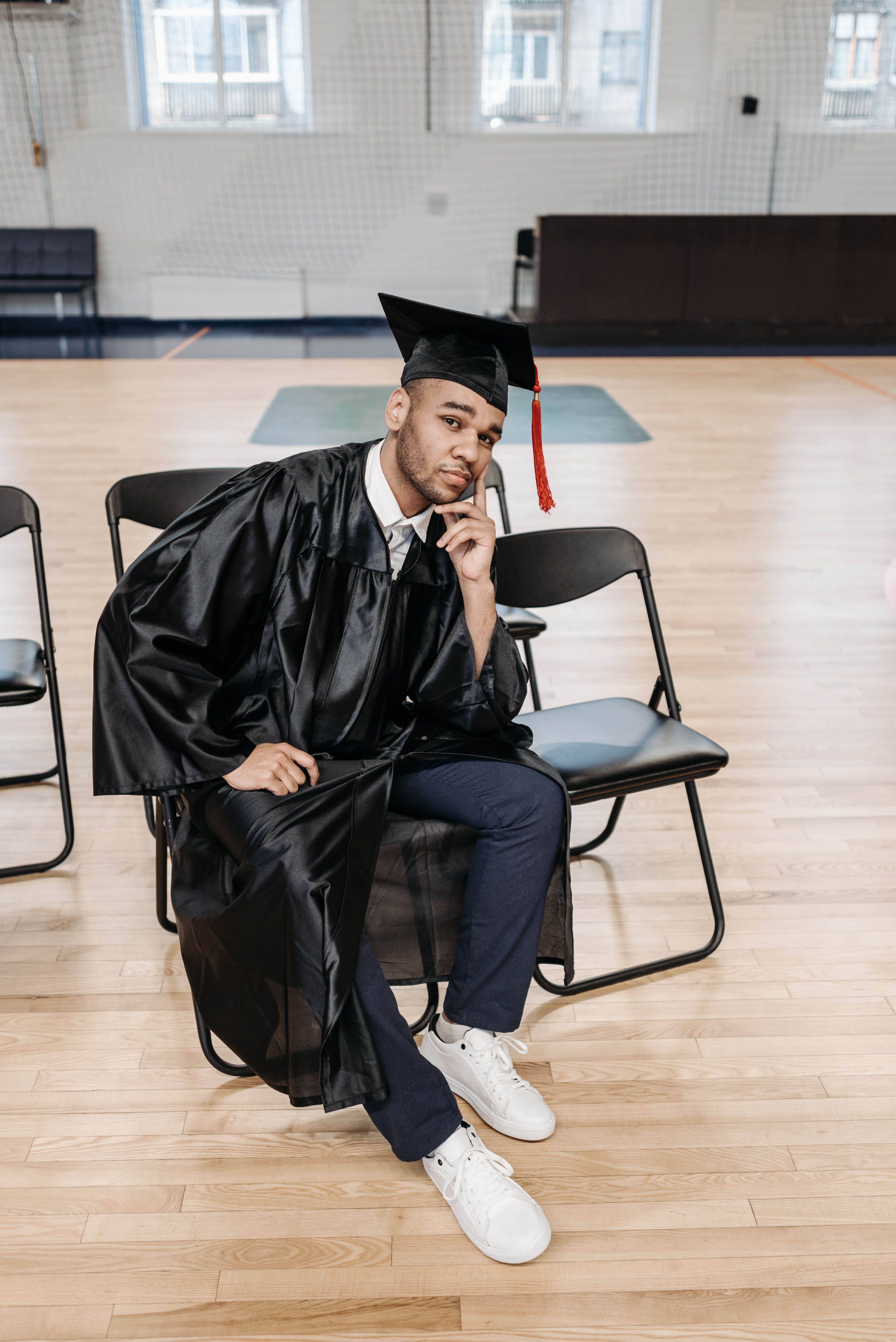 Photo of Man in Black Academic Dress Sitting on Chair · Free Stock Photo