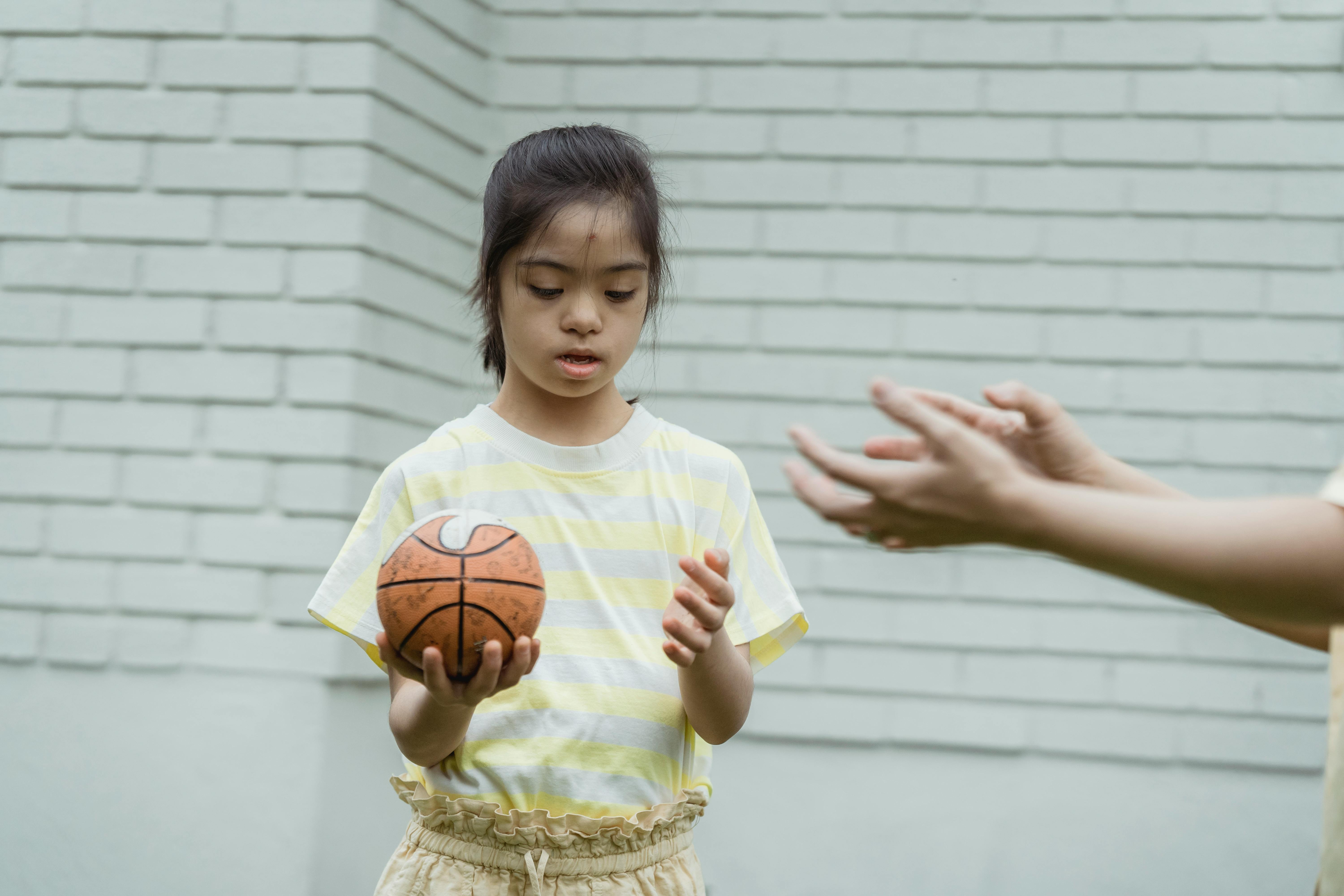 Cute Girl holding a Ball · Free Stock Photo