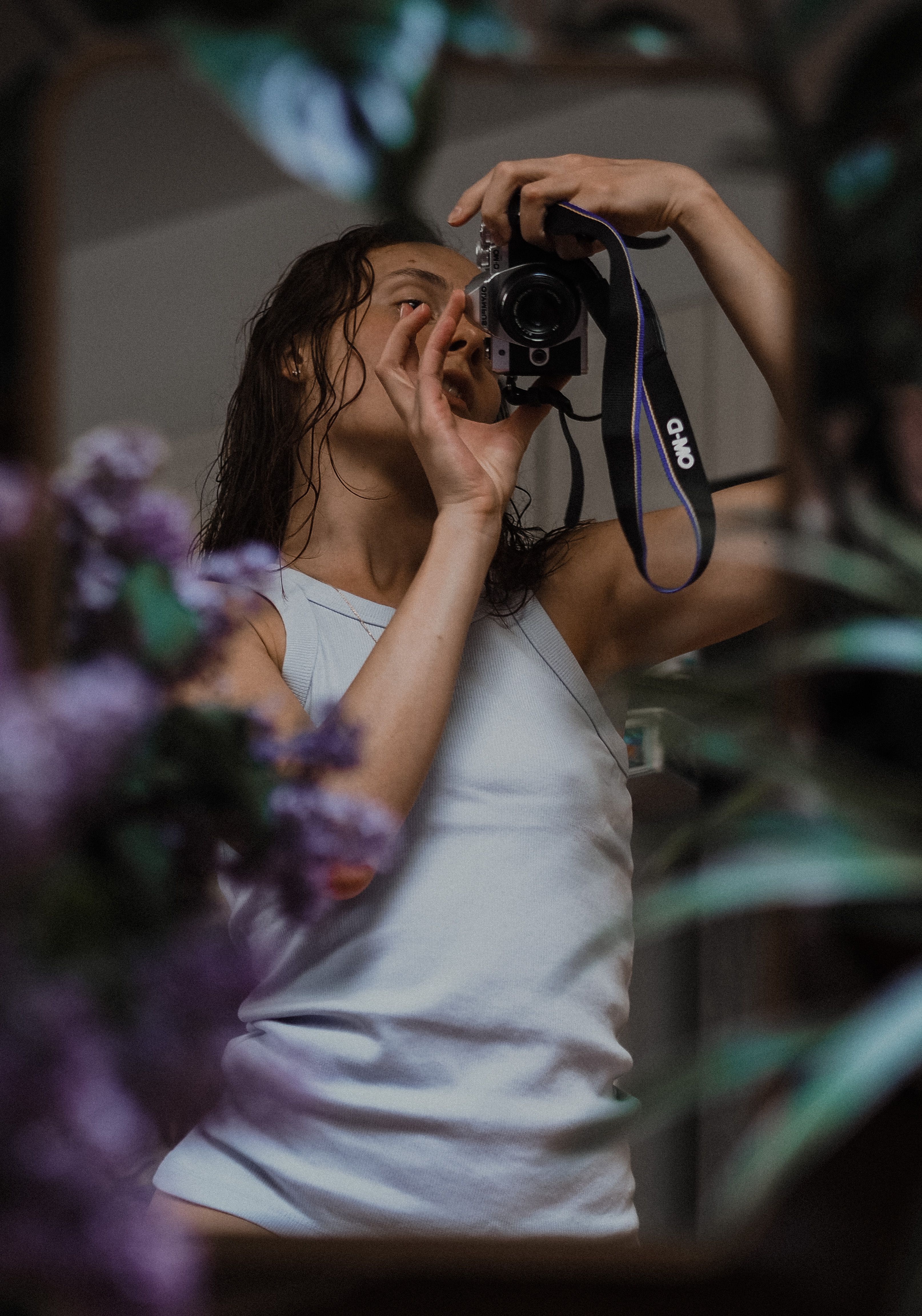 Young person adjusting photo camera near window · Free Stock Photo