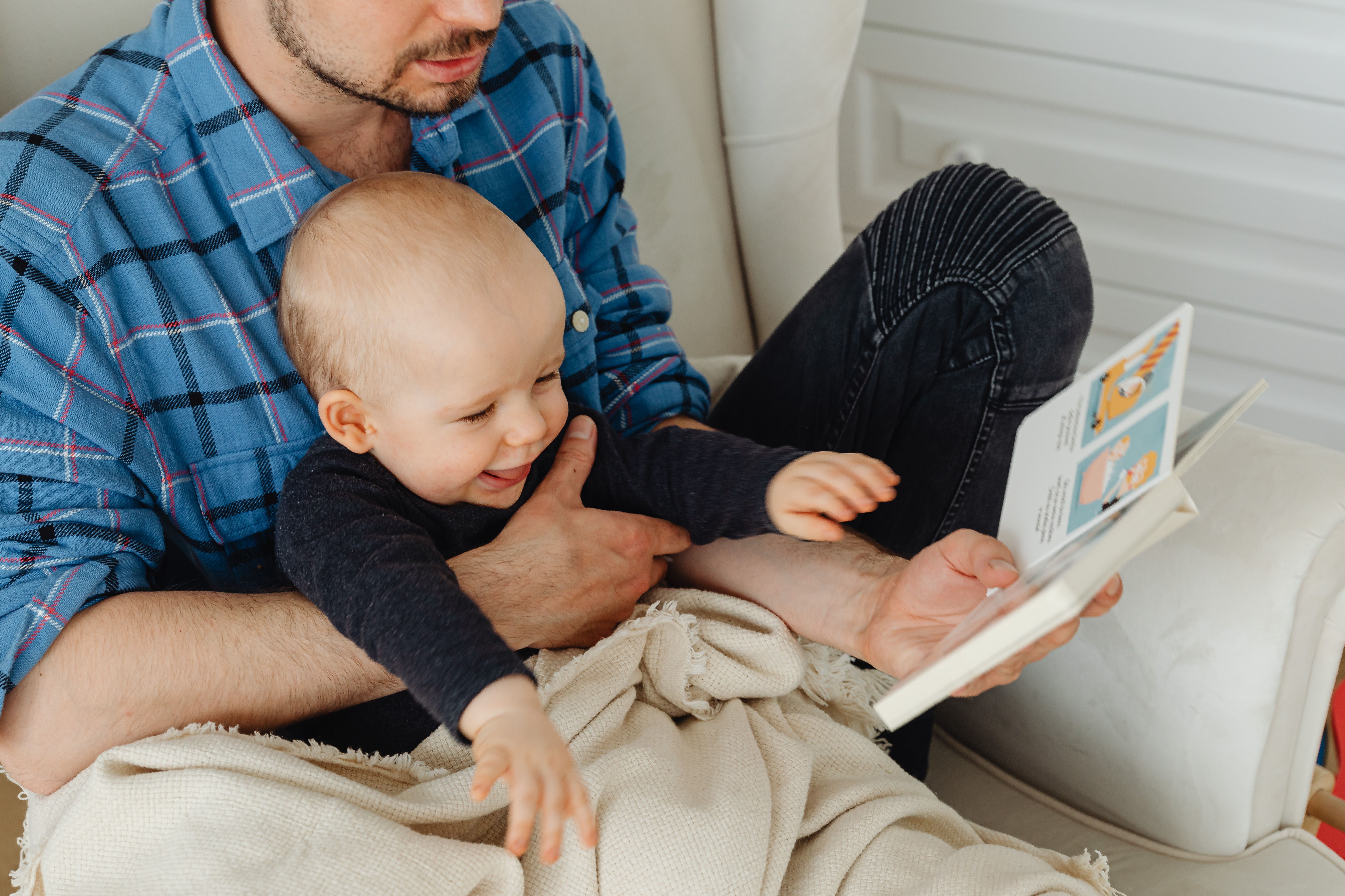 Photo Of Man And Child Reading Book During Daytime · Free Stock Photo
