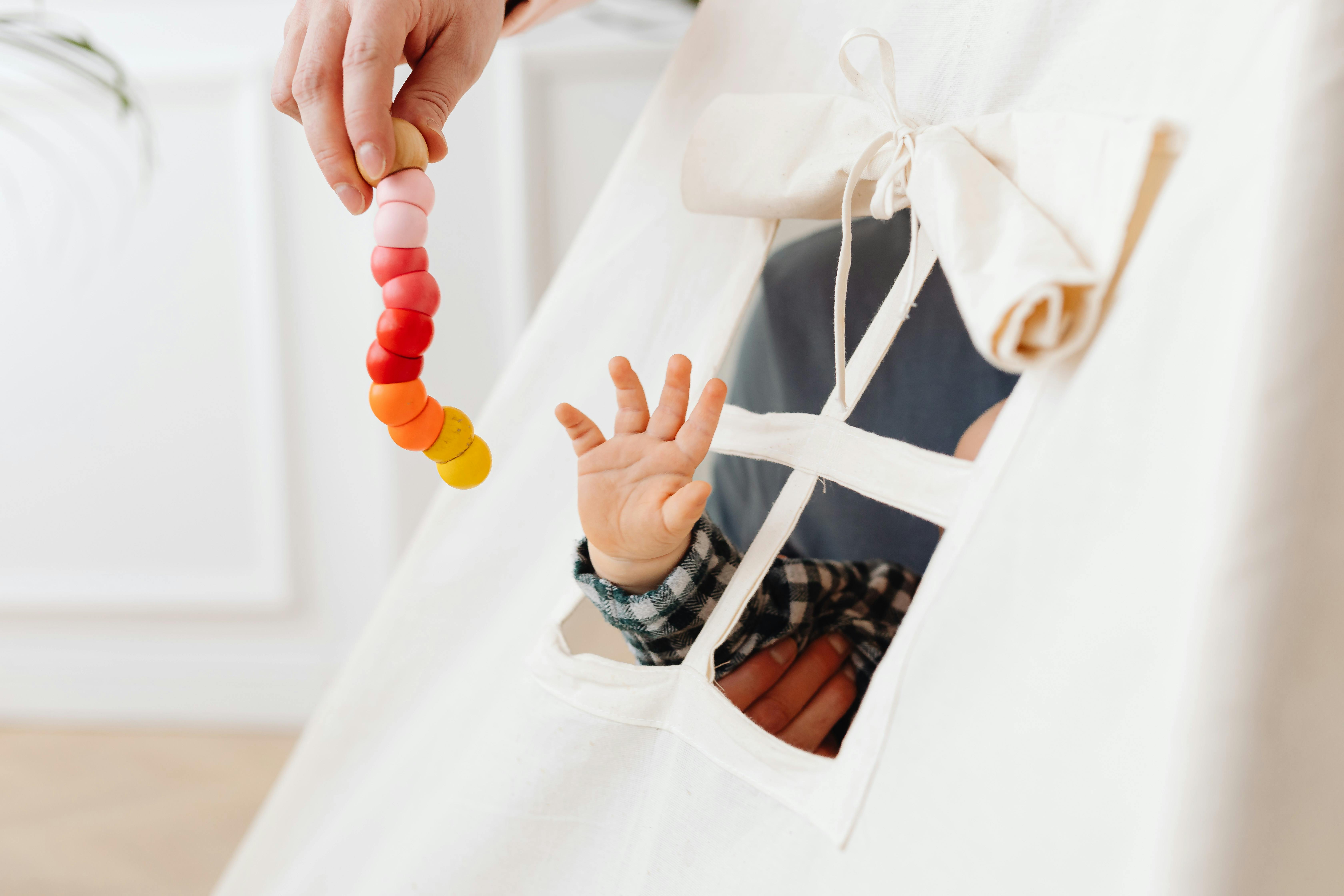 A Baby Reaching For a Toy · Free Stock Photo