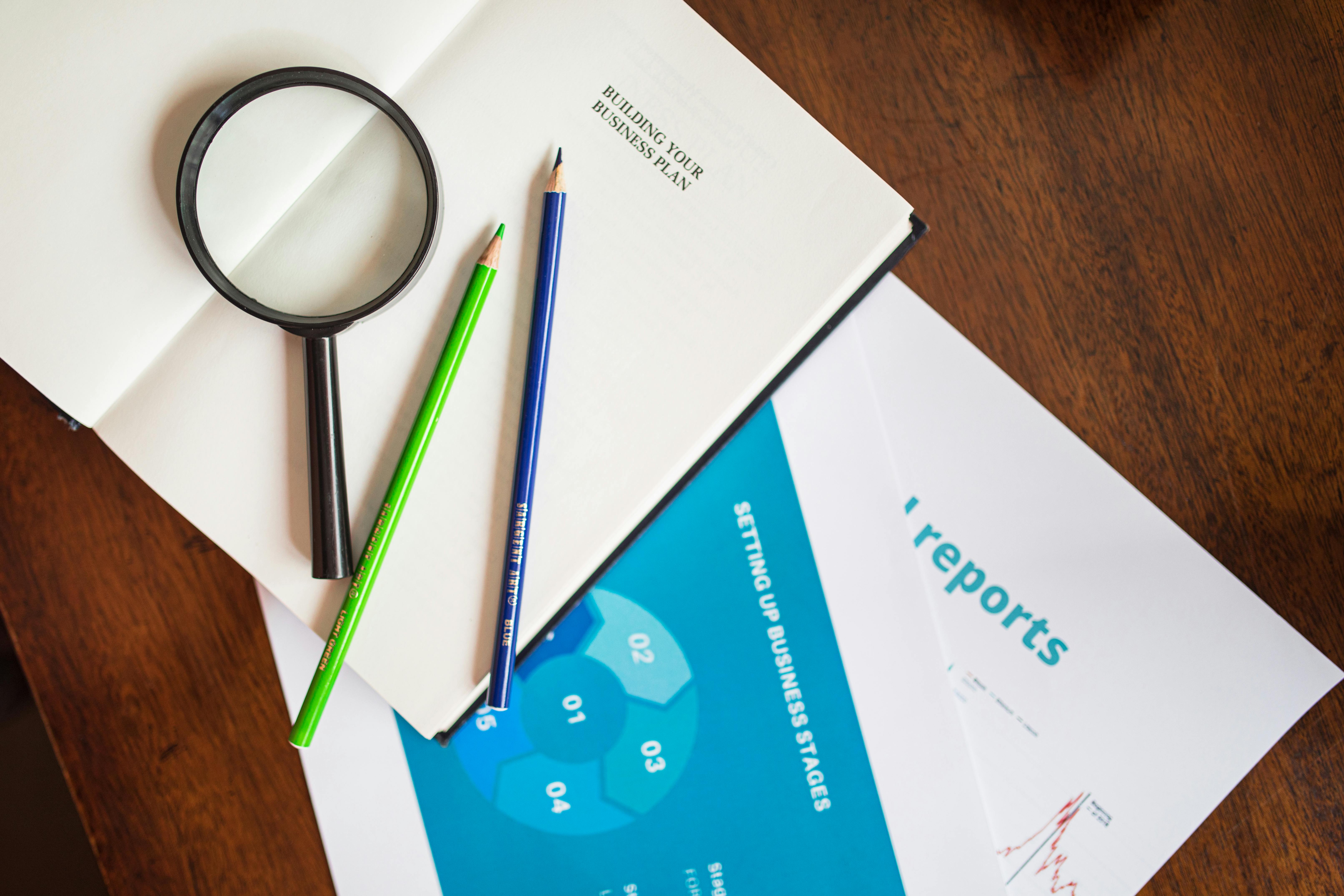 Magnifying Glass on White Paper · Free Stock Photo