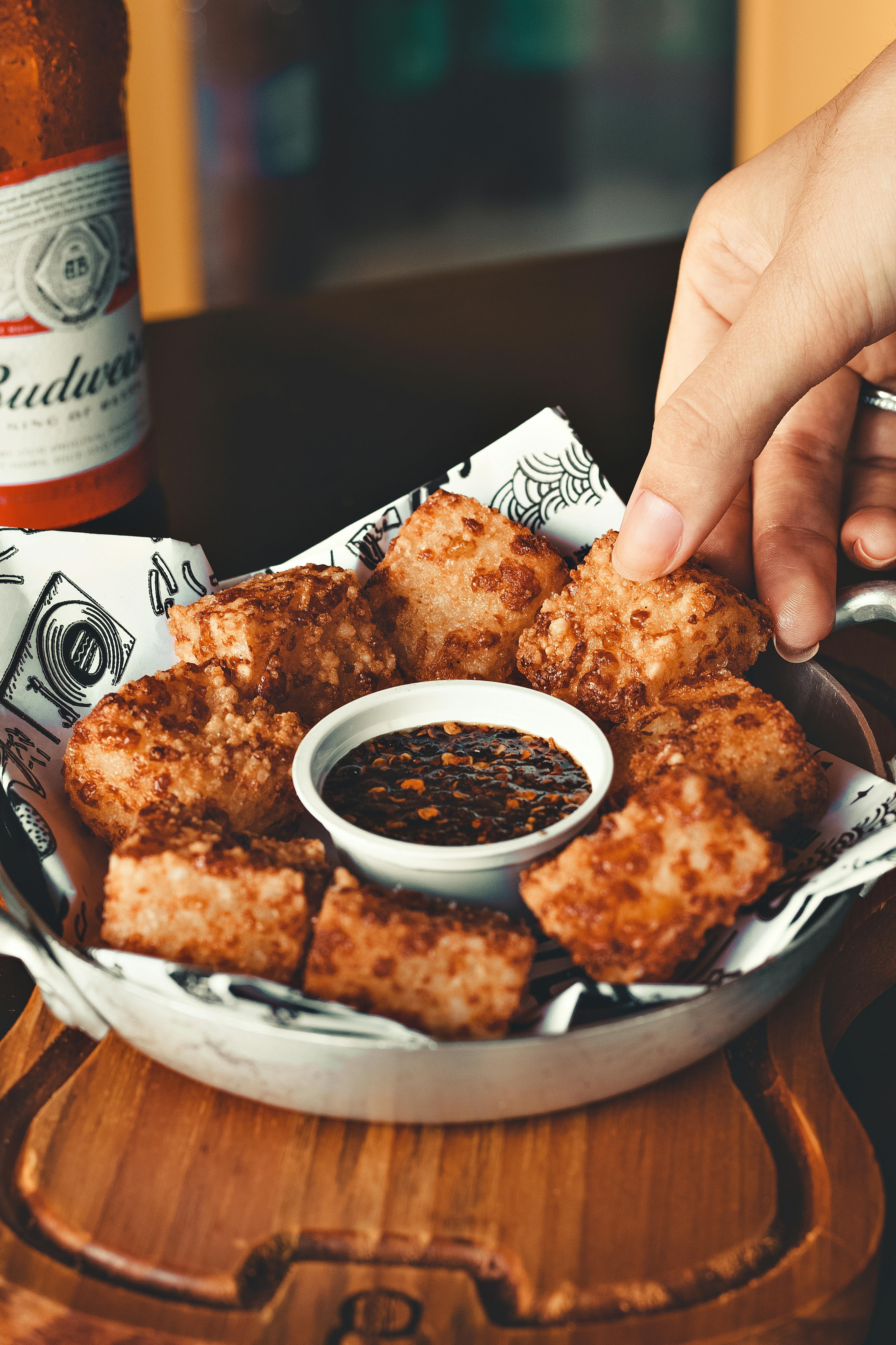 Close-Up Shot of a Person Holding Fried Food · Free Stock Photo